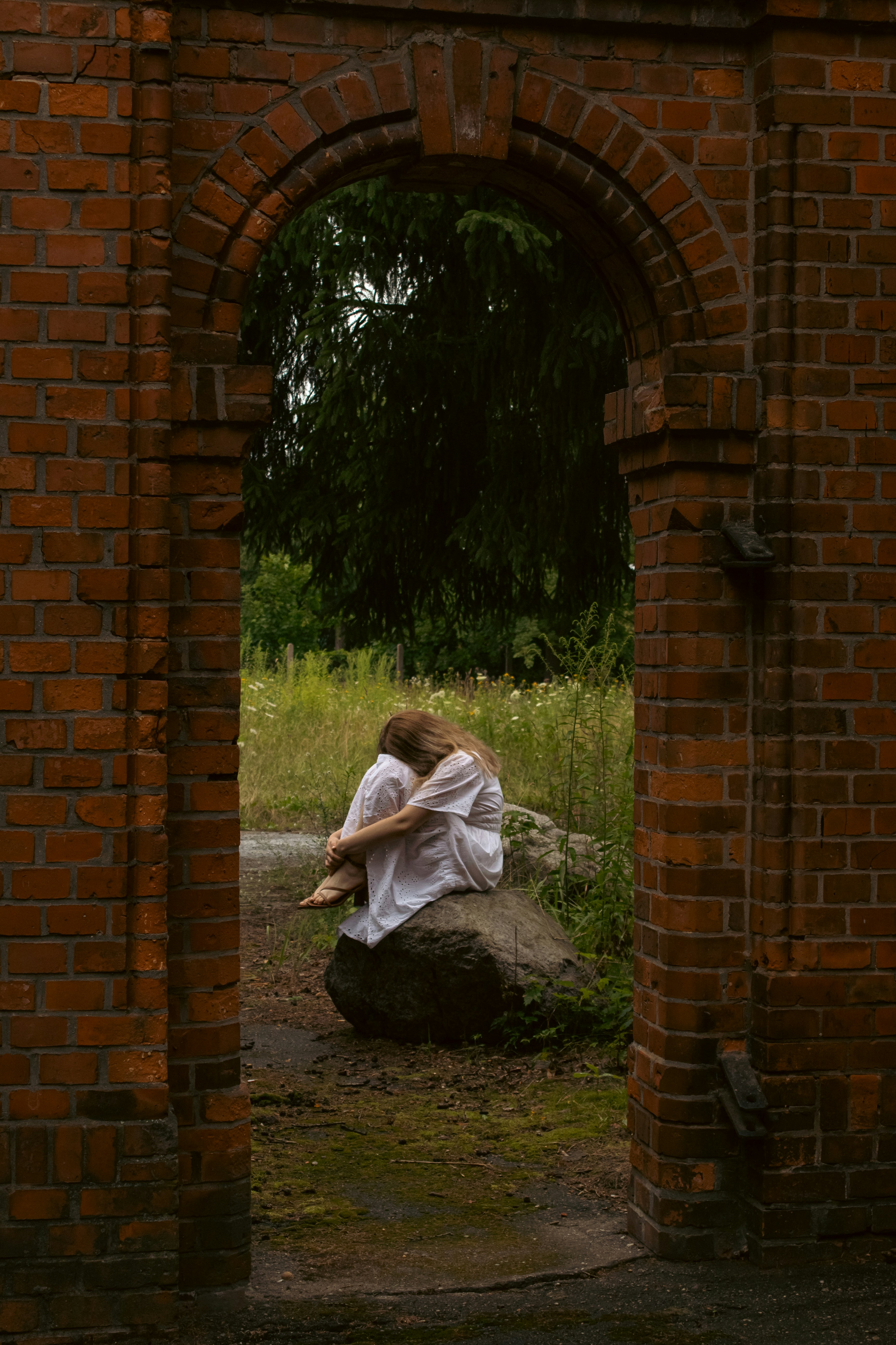 Within the Brick Archway, Lovers Rest on a Mossy Rock