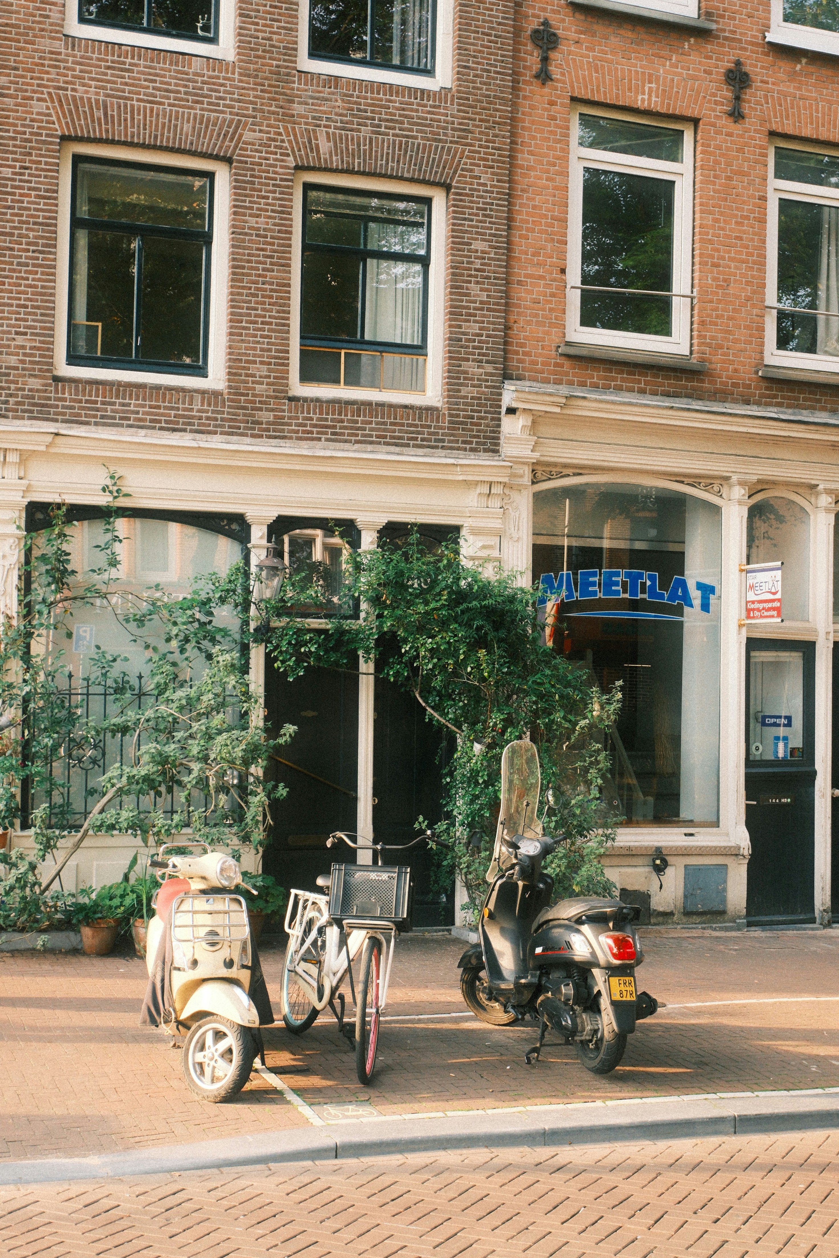 Street Caféfront with Scooters and Glass Door MeetLat