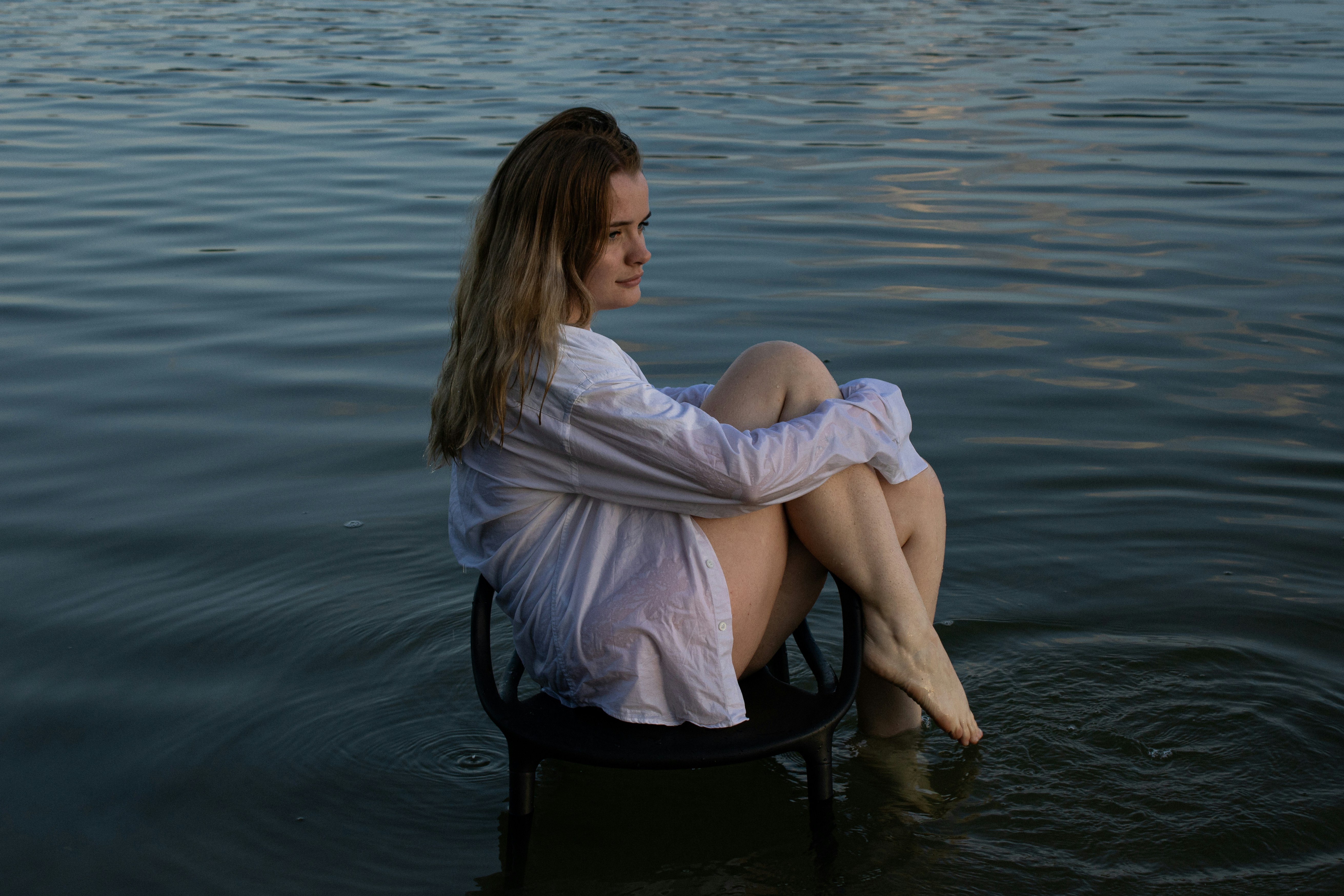 The Quiet Recline: Woman in Water on a Gentle Surface