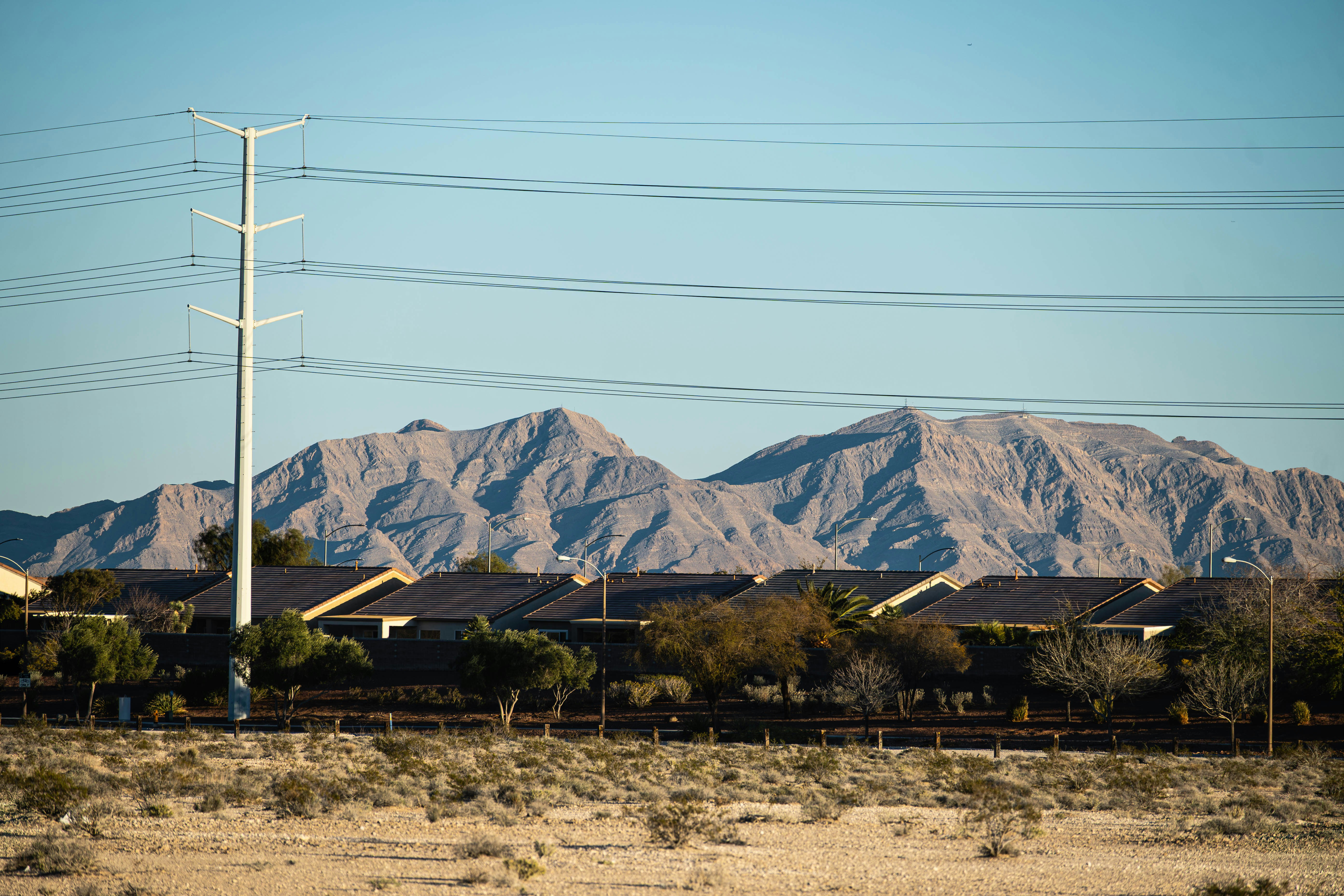 Desert Suburb Under Ridge: Quiet Horizon Against Rocky Peaks