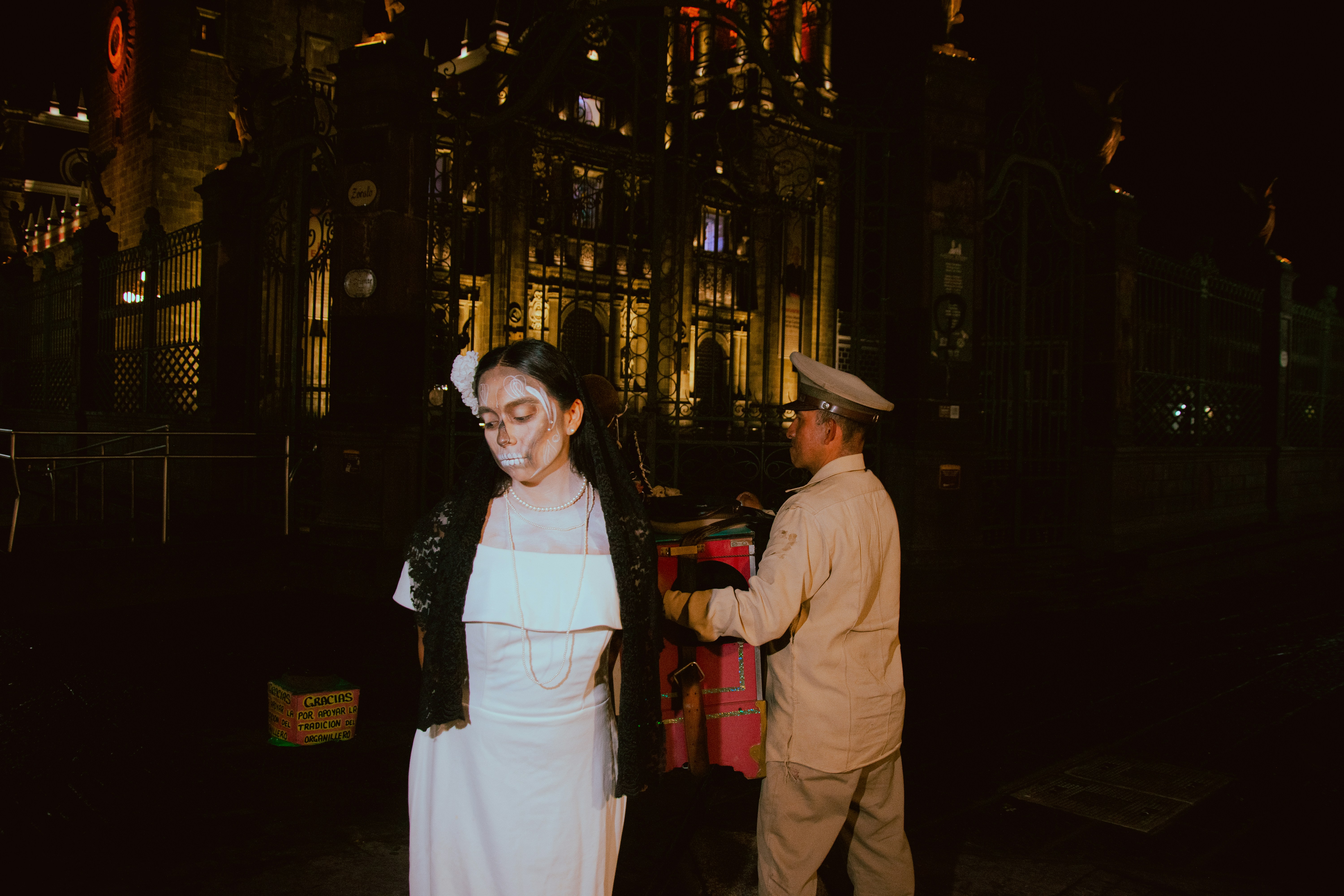 Nighttime Encounter: A Woman in White Amid Gentle Street Light
