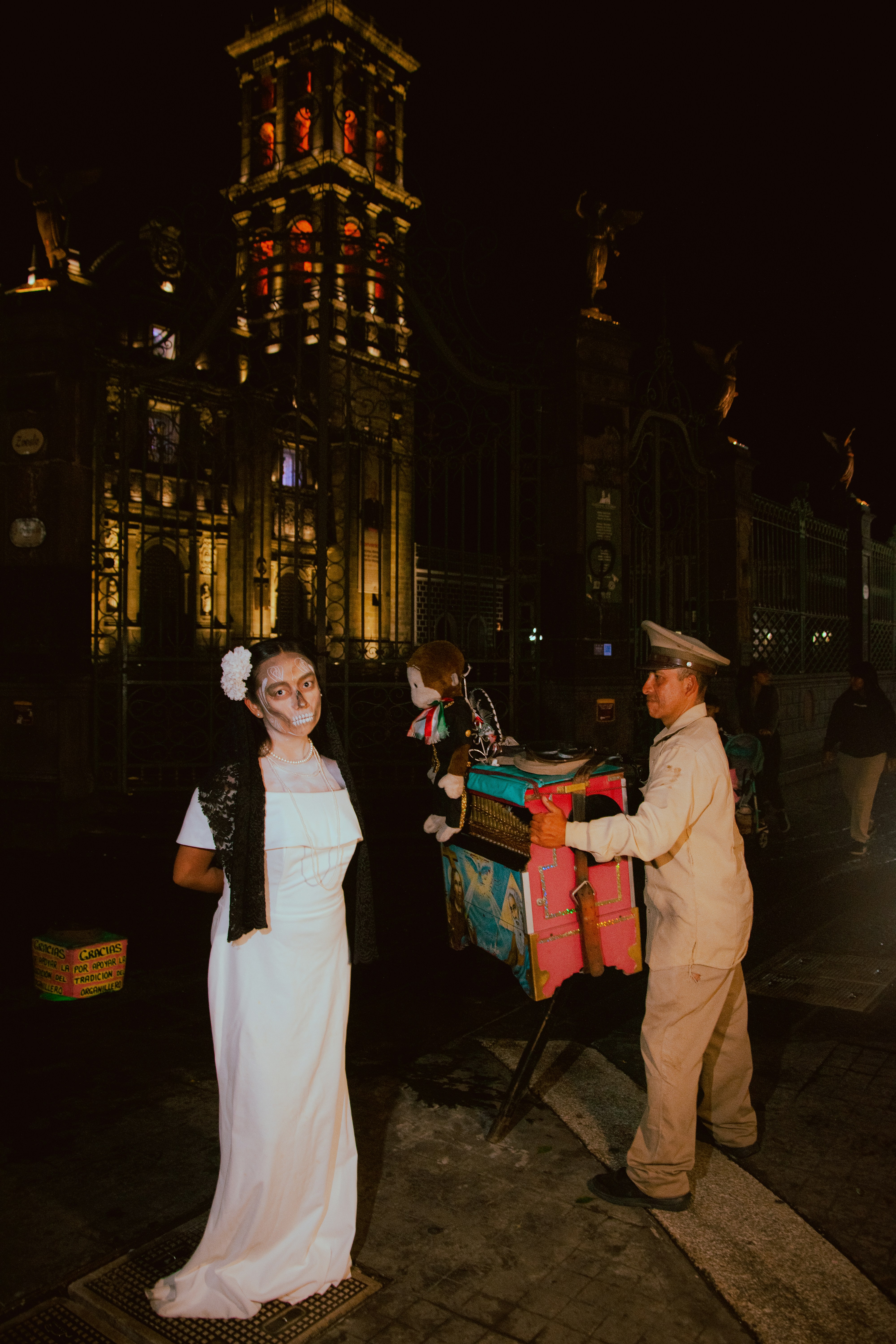 Midnight Encounter: A Street Vendor in Front of a Lit Cathedral Facade