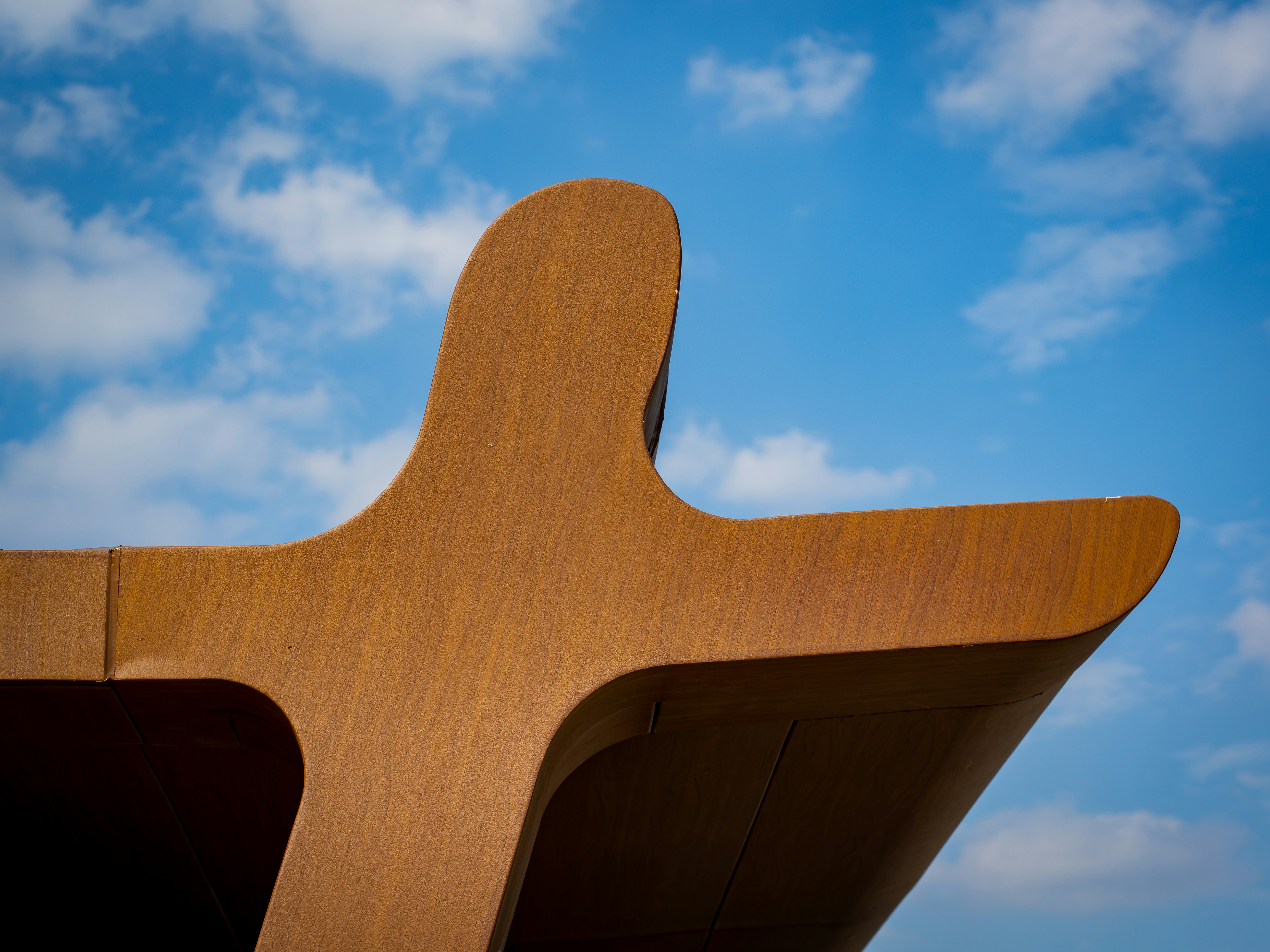 Curved Wooden Peak Against a Clear Sky