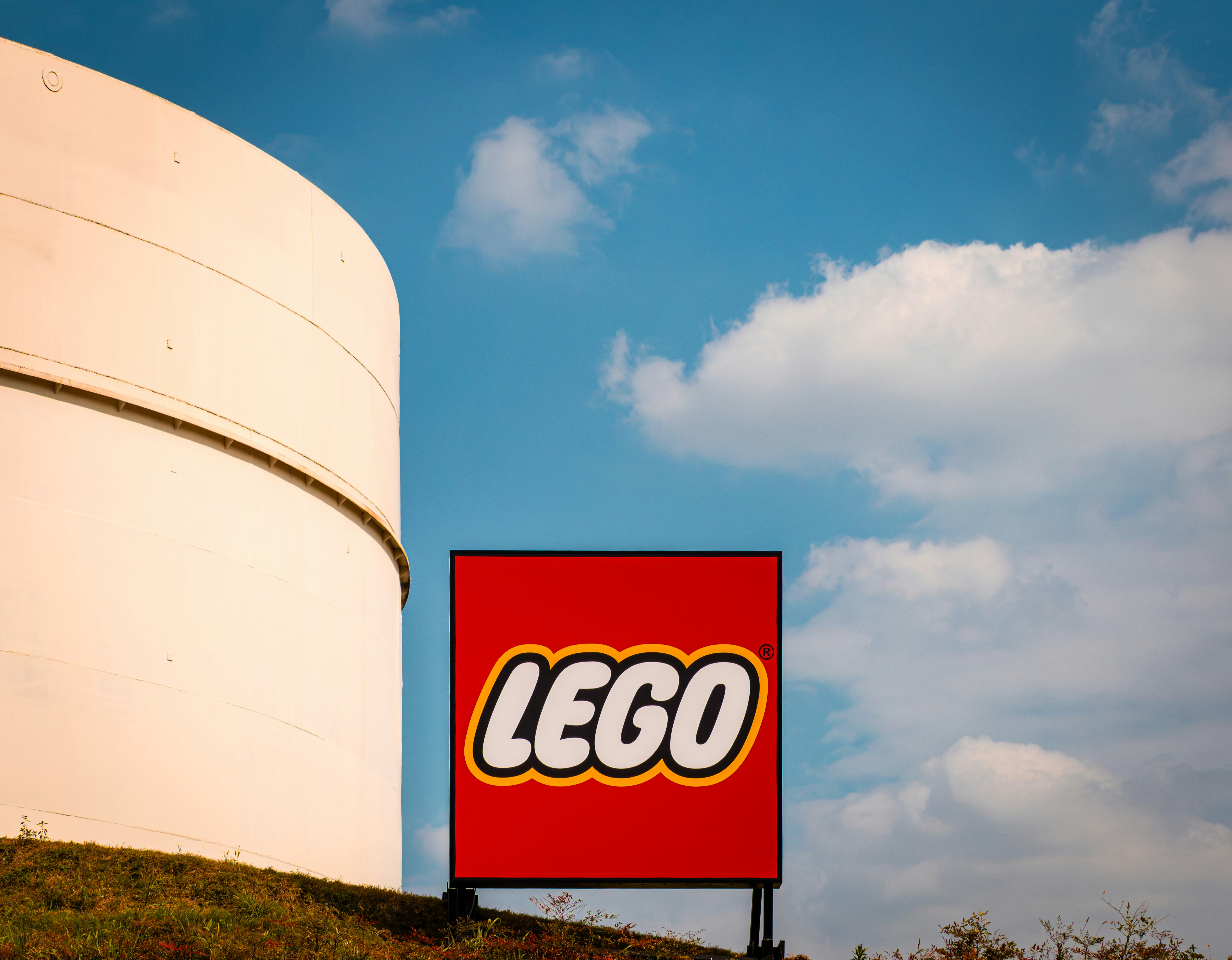 LEGO Billboard by a Curved Tank Under a Clear Sky