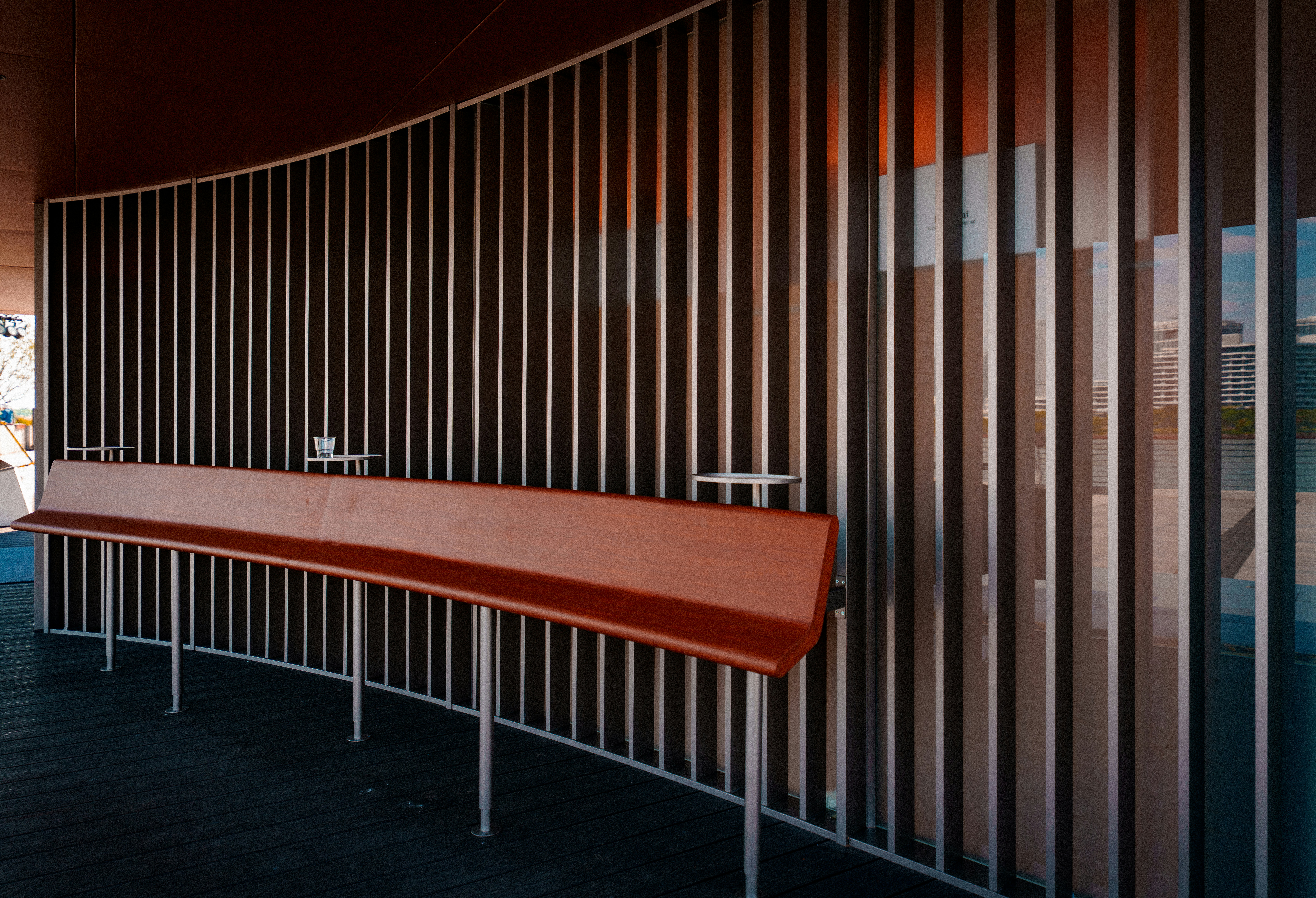 Red Bench Beneath Vertical Lines