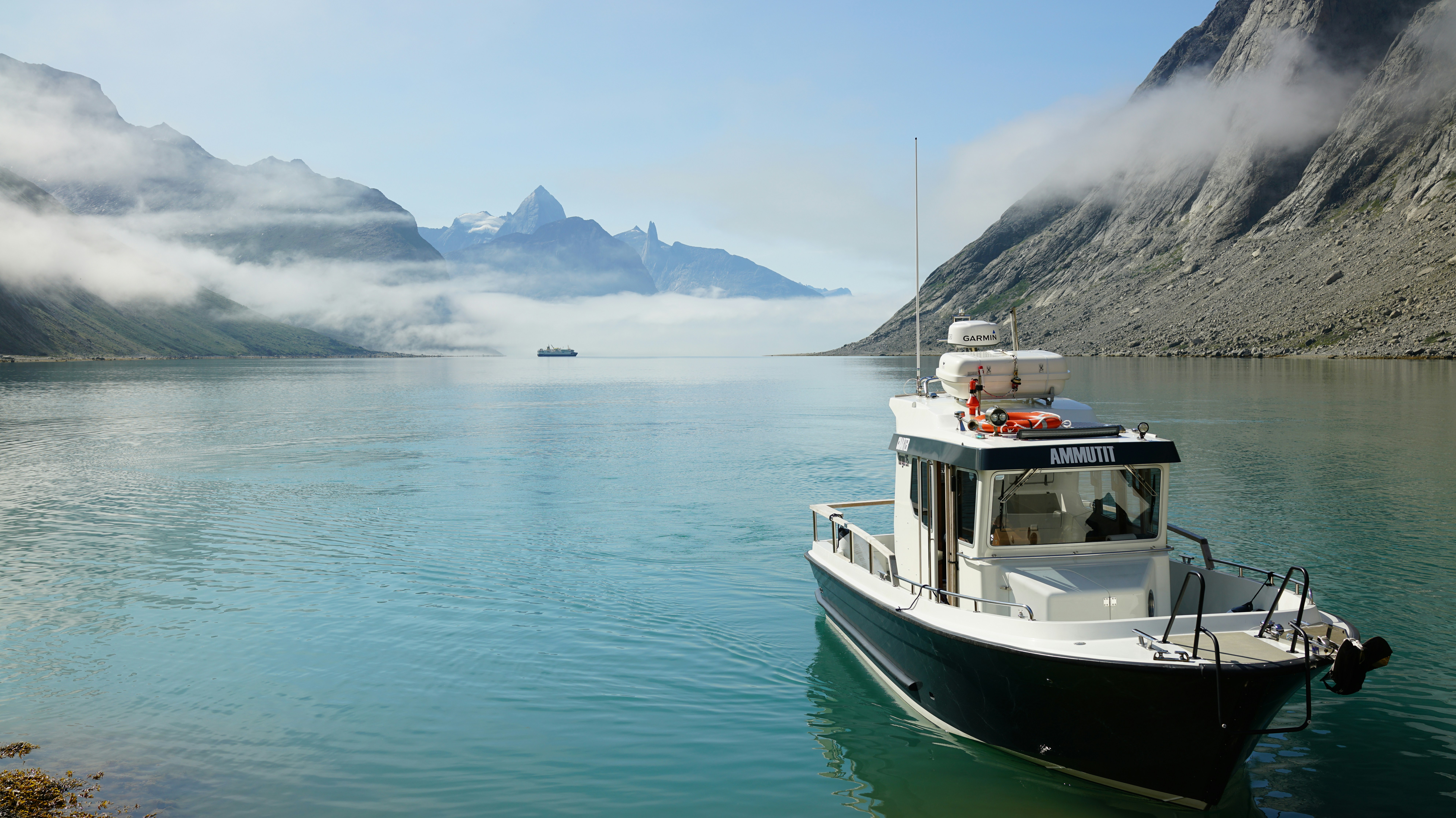 Blue Fjord’s Quiet Patrol: A Vessel Anchored Amid Alpine Silence