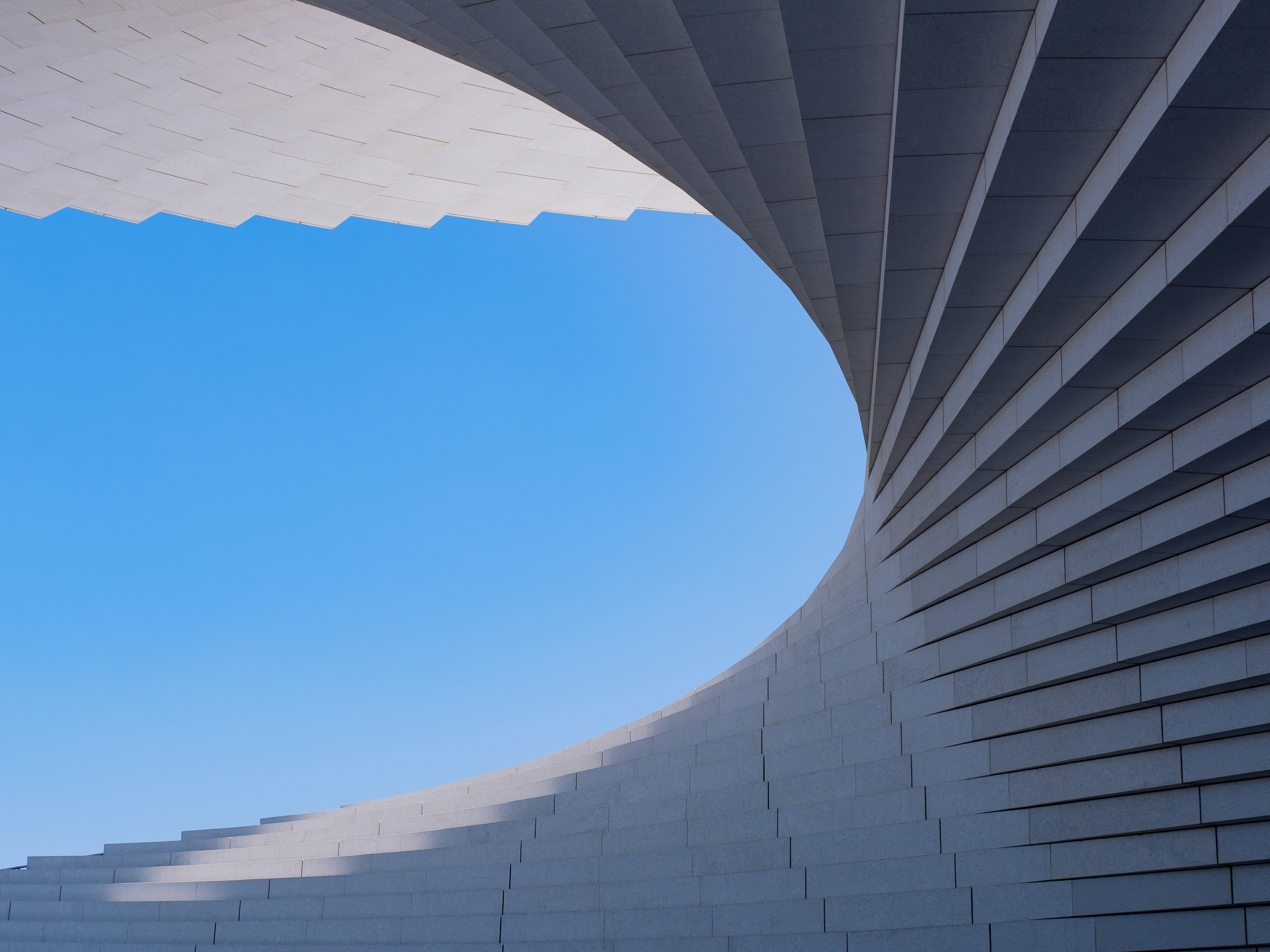 Curved Concrete Convergence under a Vivid Blue Sky