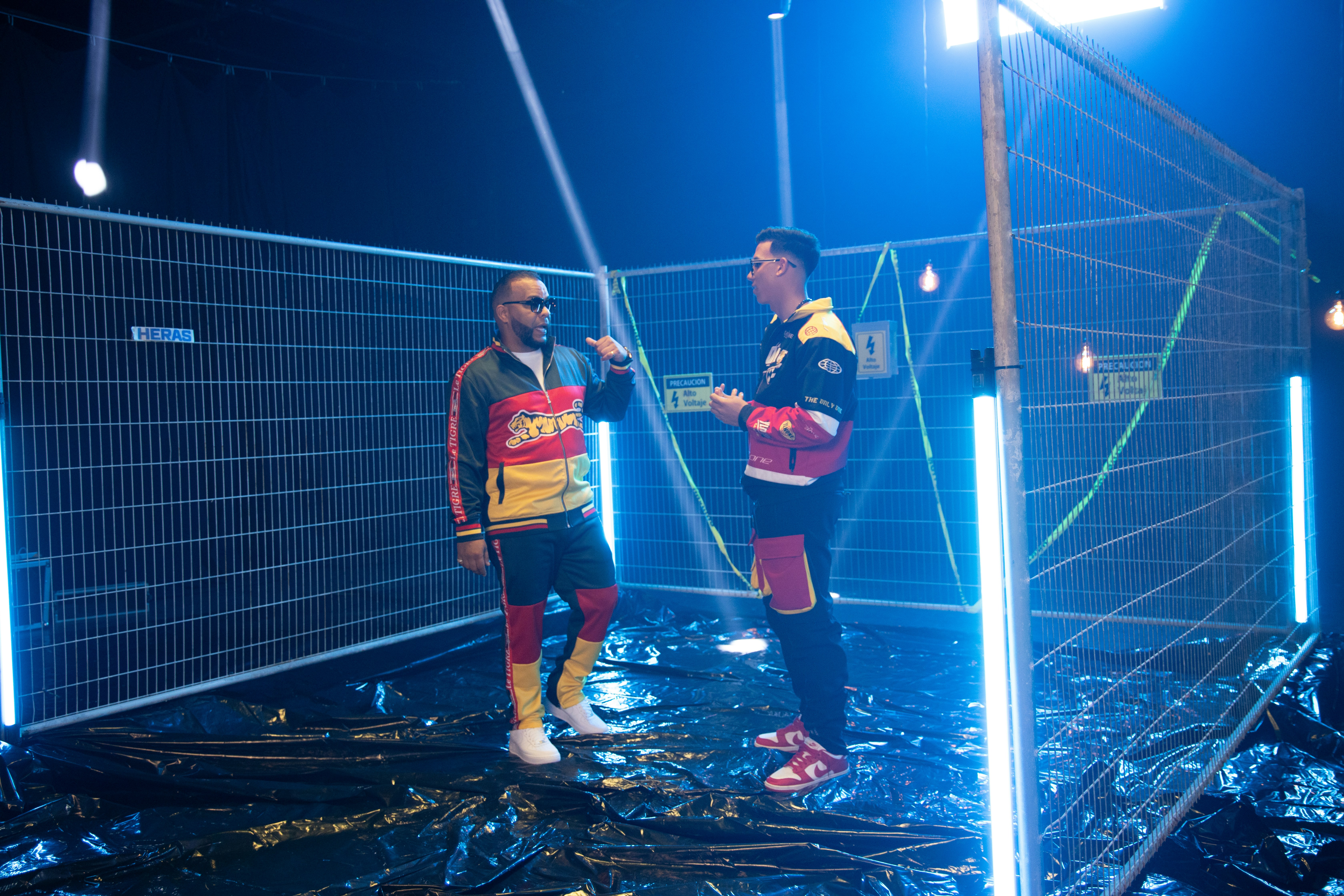 Night talk in a glove-lit enclosure: athletes in vibrant team kit