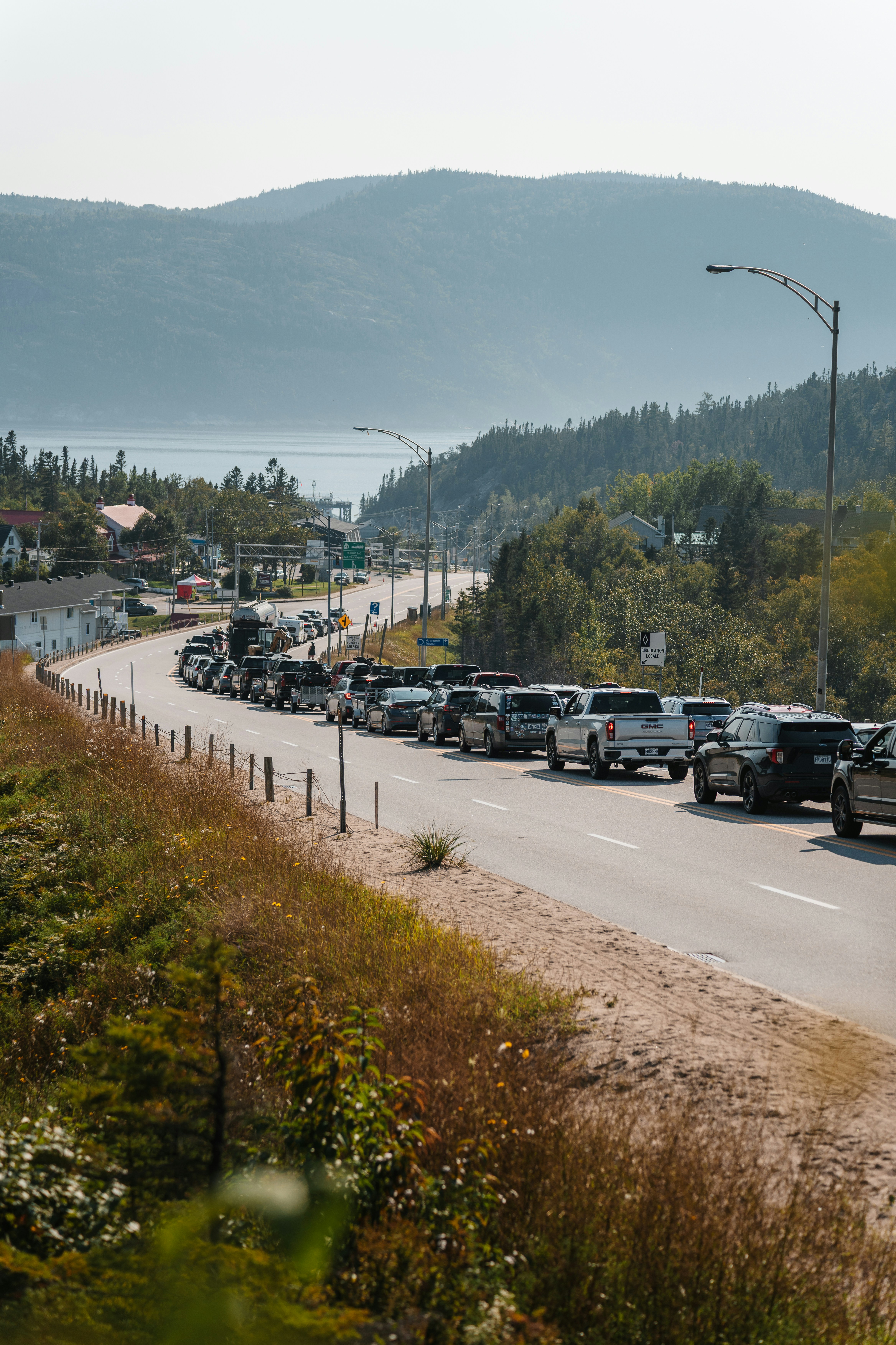 Cars Line the Coastal Highway as Hills and Sea Fray the Horizon