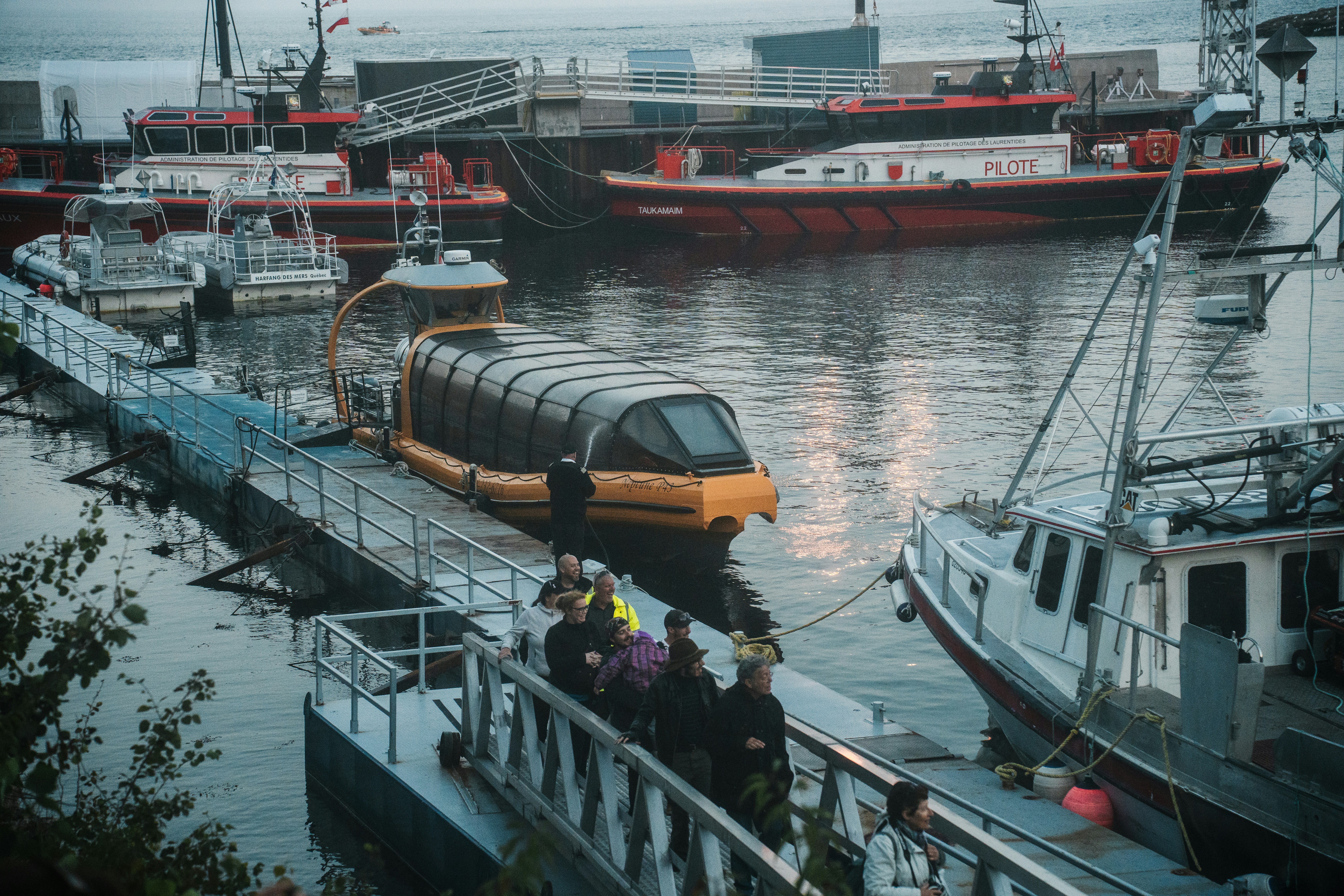 Harbor Walkway: People Descend from a Yellow Boat at Dusk