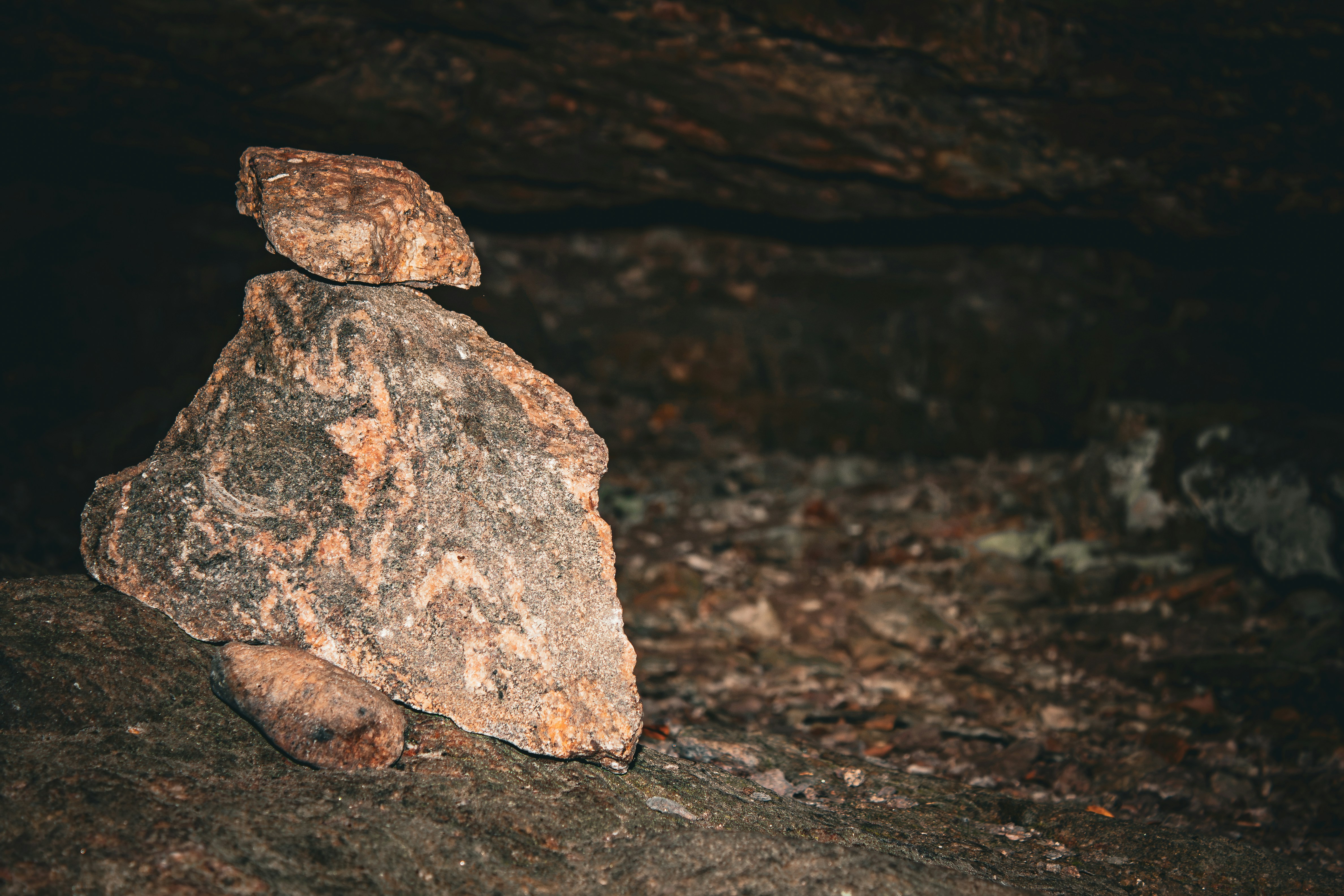 Stack of Stones in Shadowed Cave