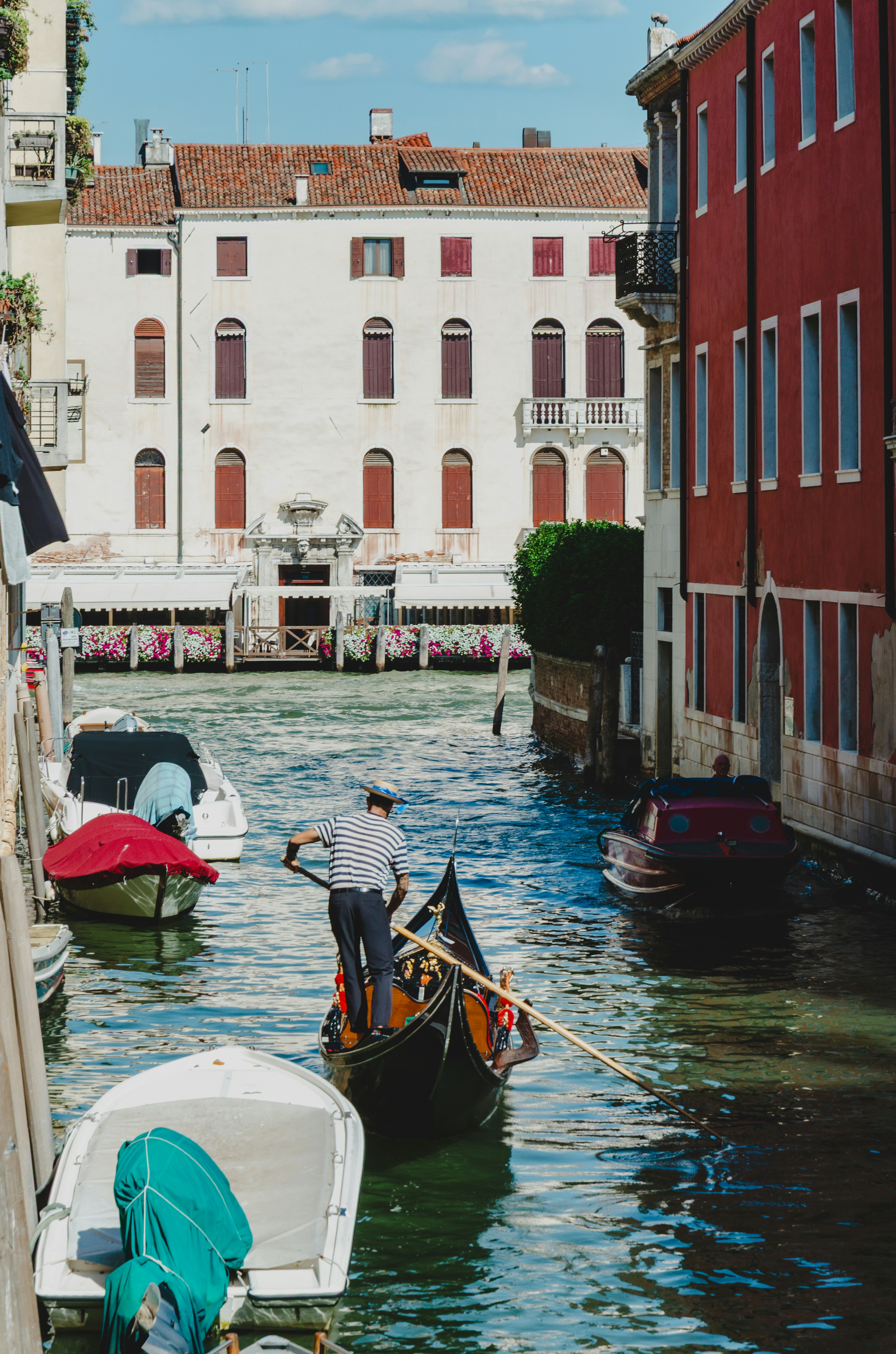 Gondolier's Path Through a Sunlit Venetian Canal