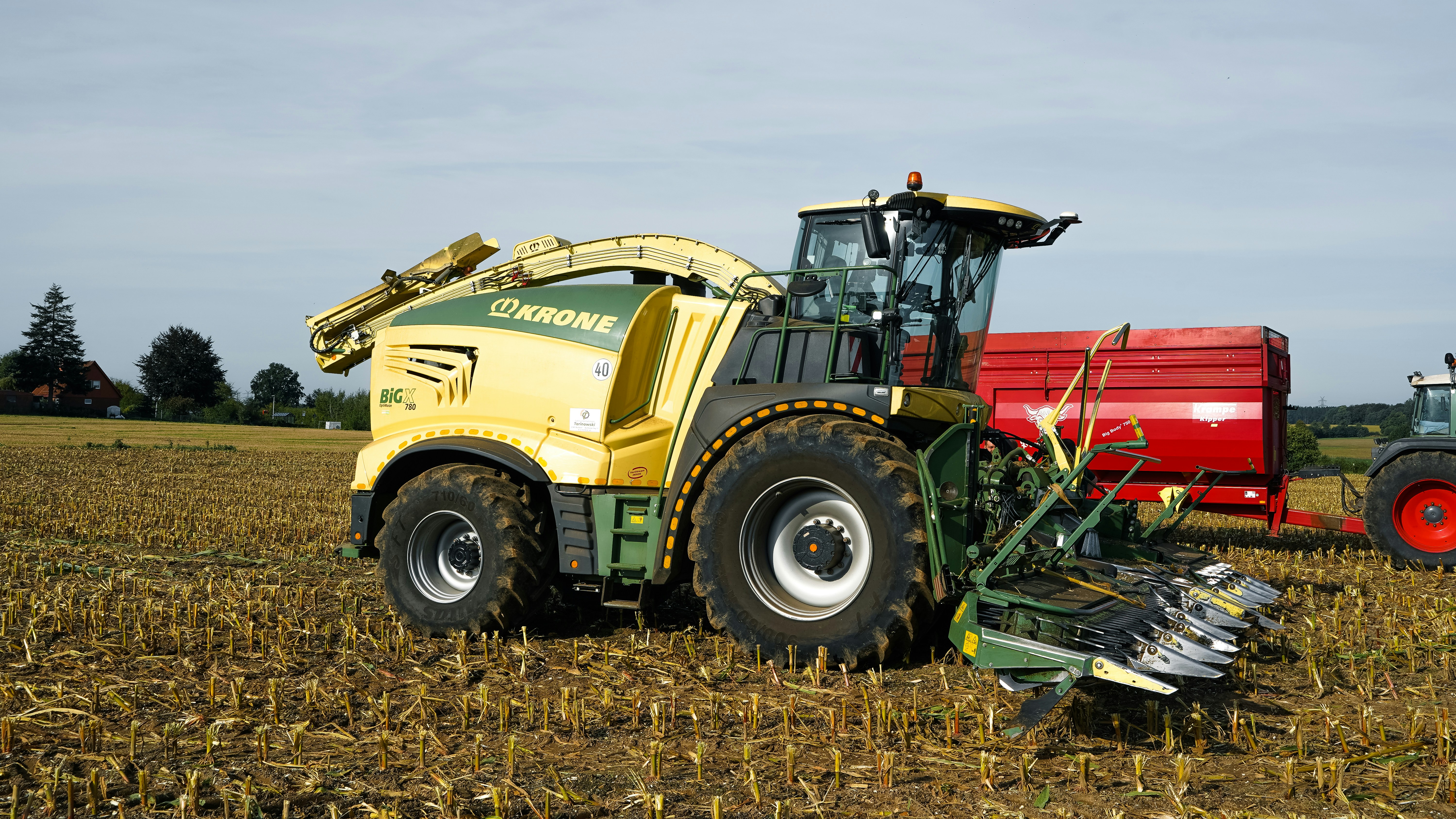Golden Harvester at First Light: A Tractor-Driven Harvest Moment