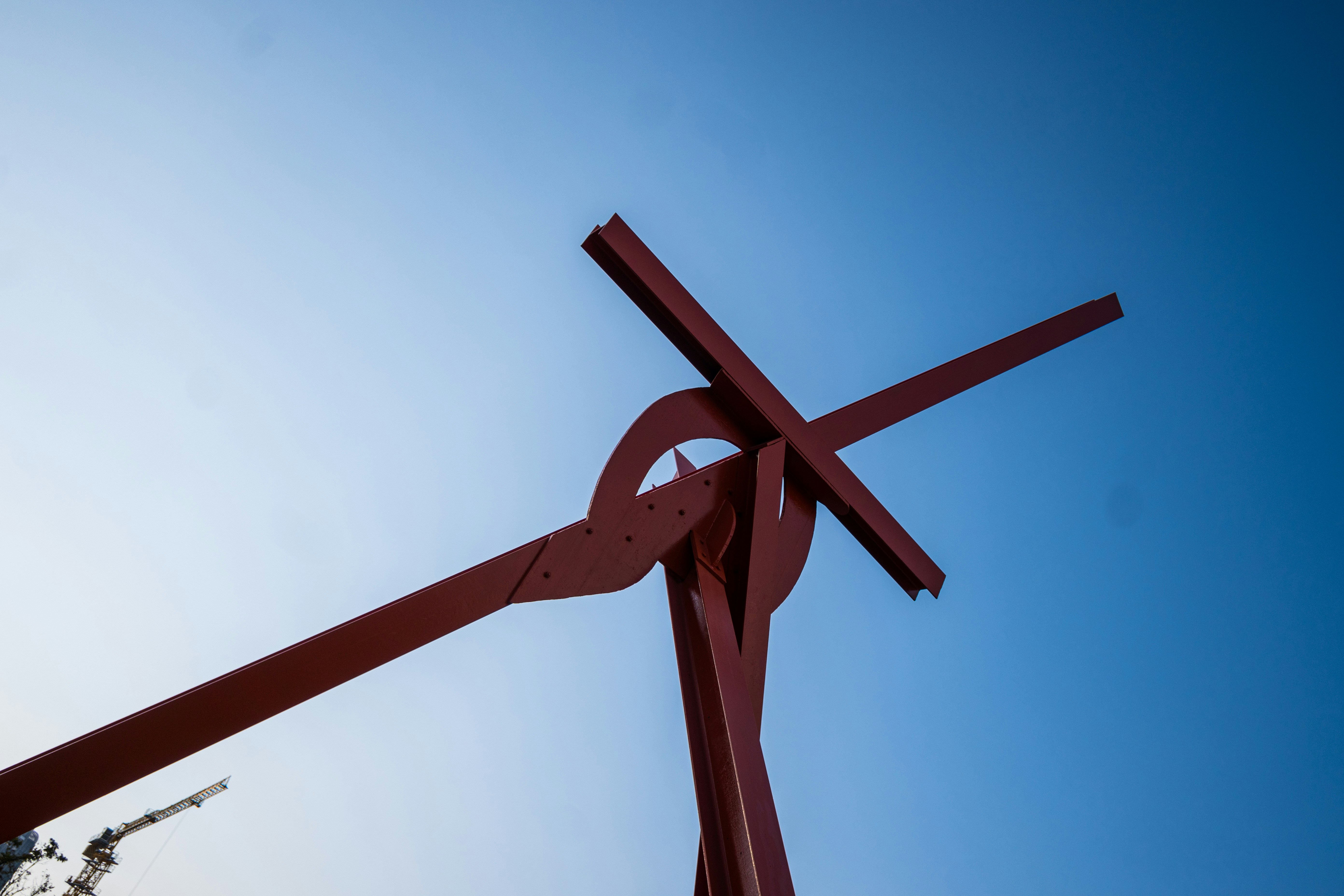 Red Steel Silhouette: Intersecting Beams Against a Clear Sky