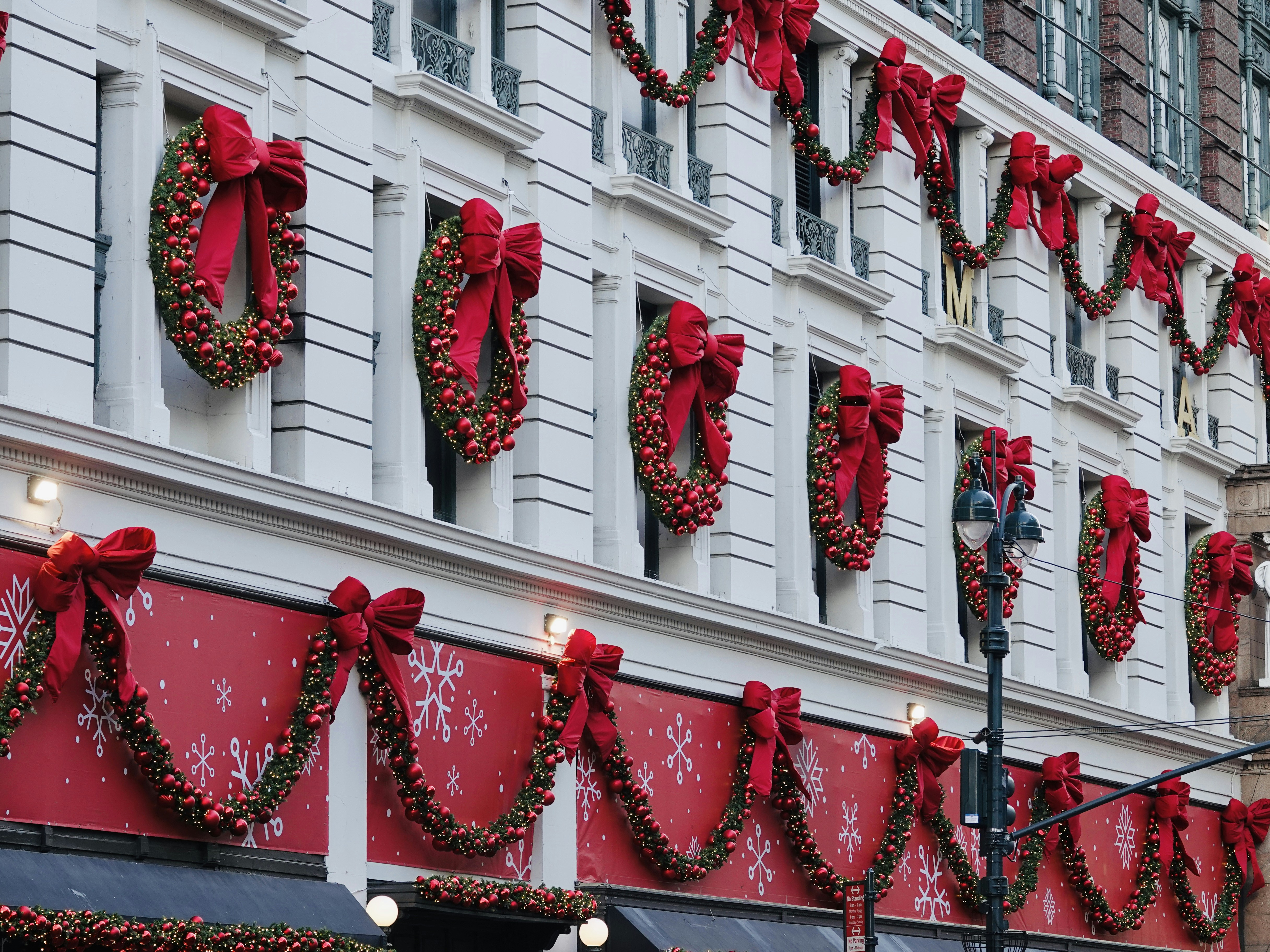 Festive Facade: A Street of Crimson Ribbons and Wreaths