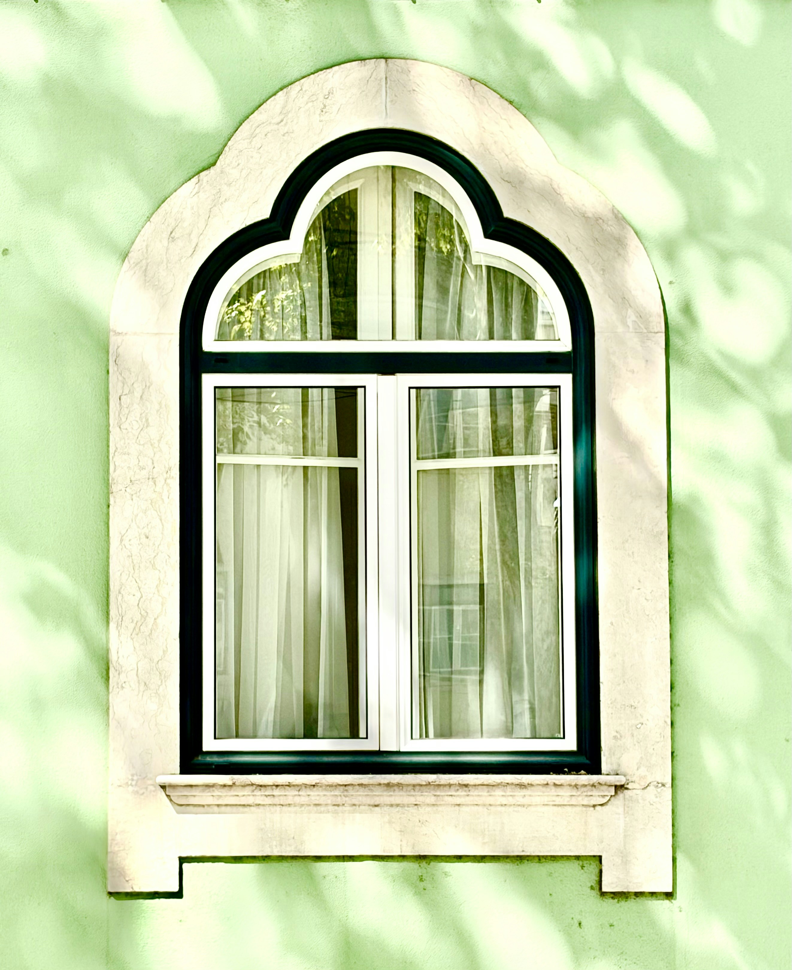 Emerald Window Frame: A Windowed Portal through Green Facade