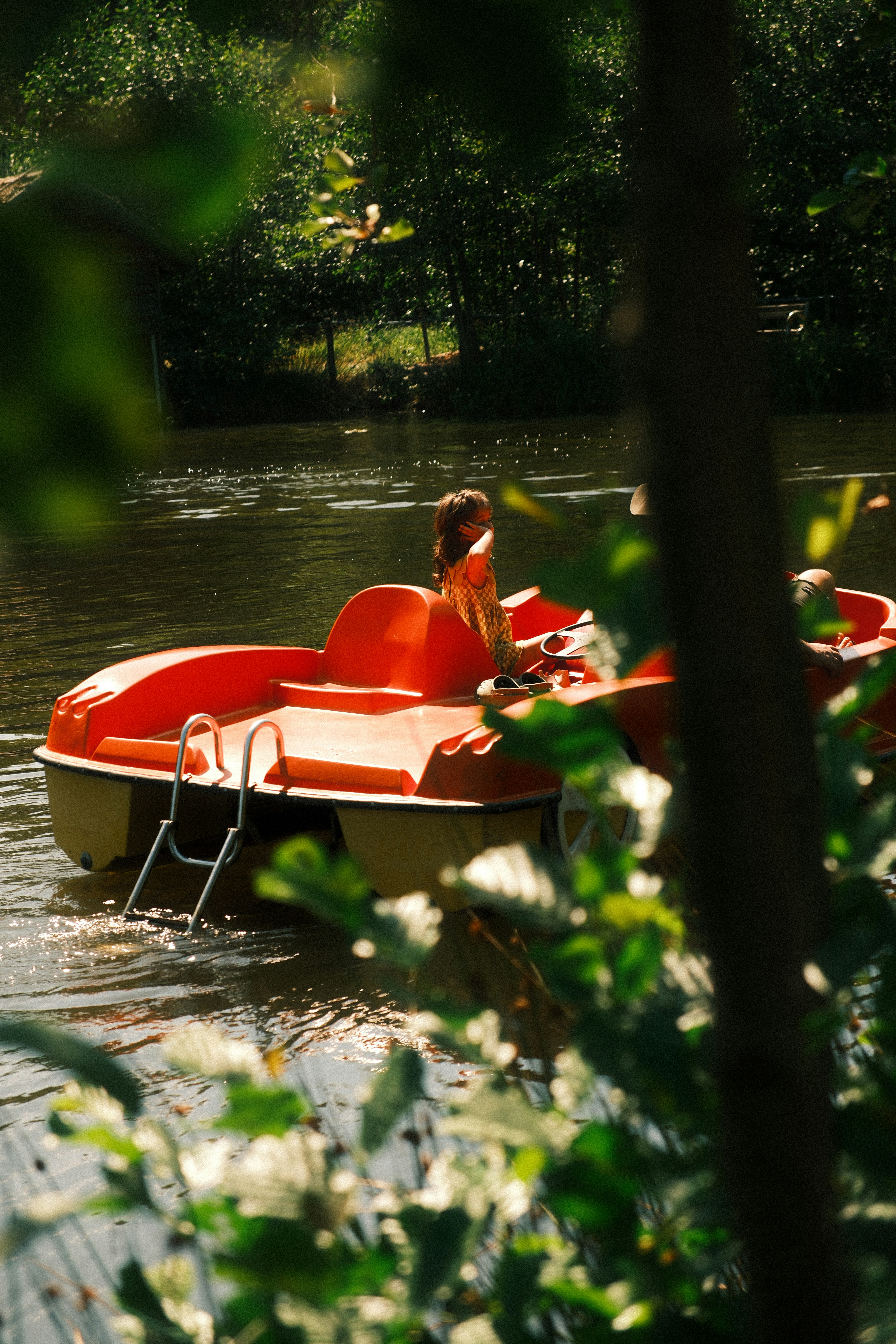 Red Boat by the Dappled Lake: Sunlit Moments in the Park