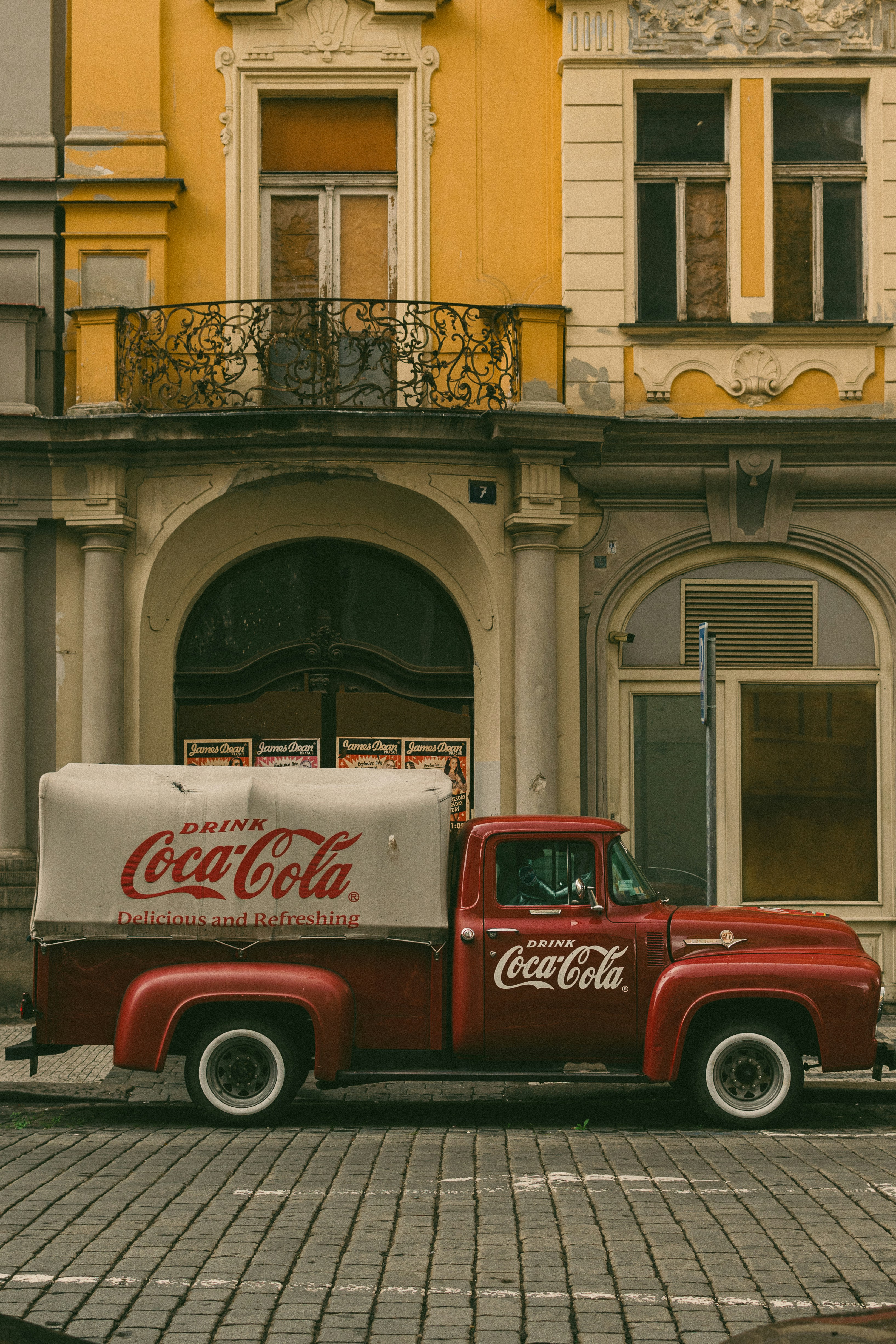 Yellow Facade, Red Coca-Cola Truck: A Quiet Street Moment in Vintage Urban Color