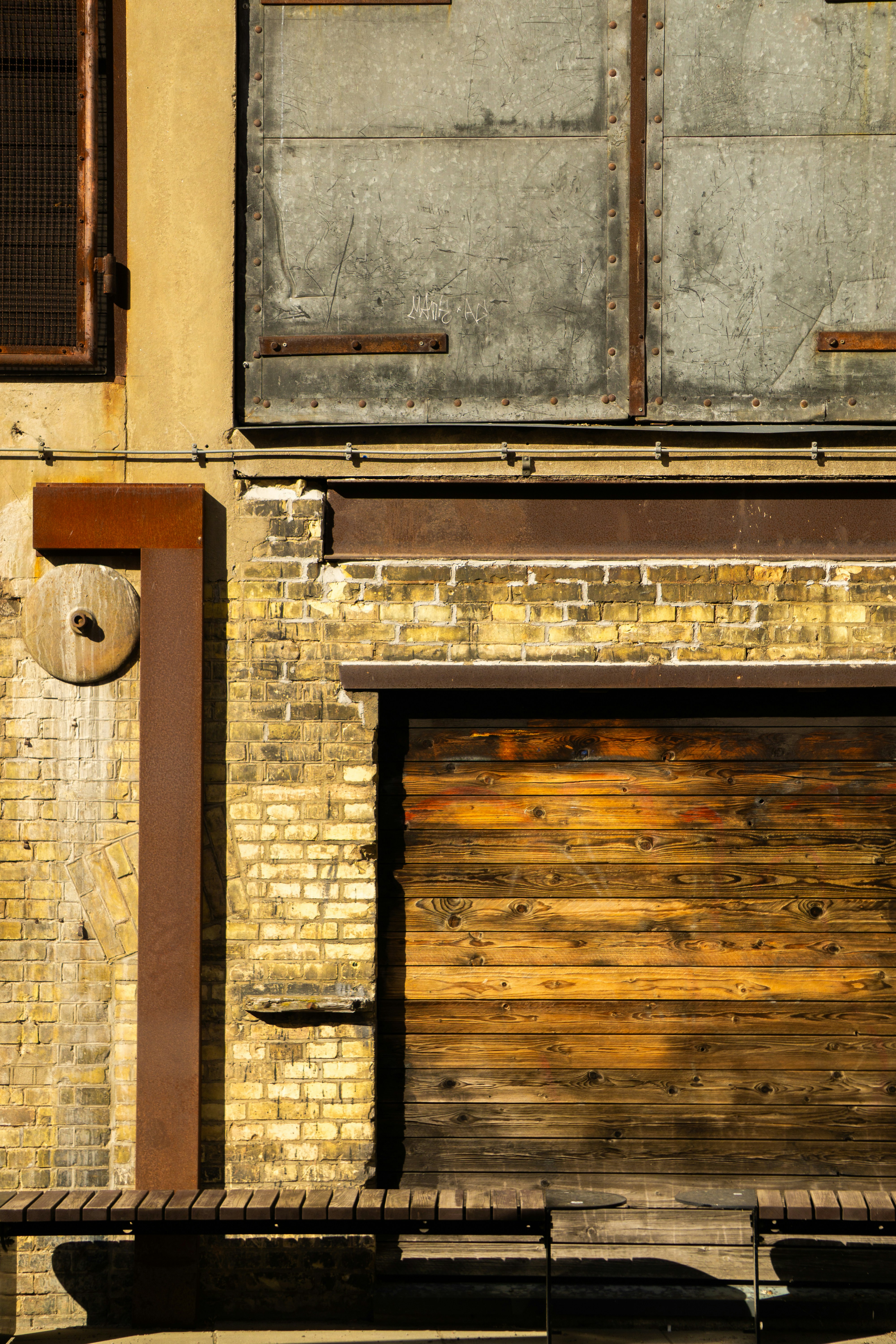 Weathered Brick and Metal Ledger: A Street-Side Industrial Facade
