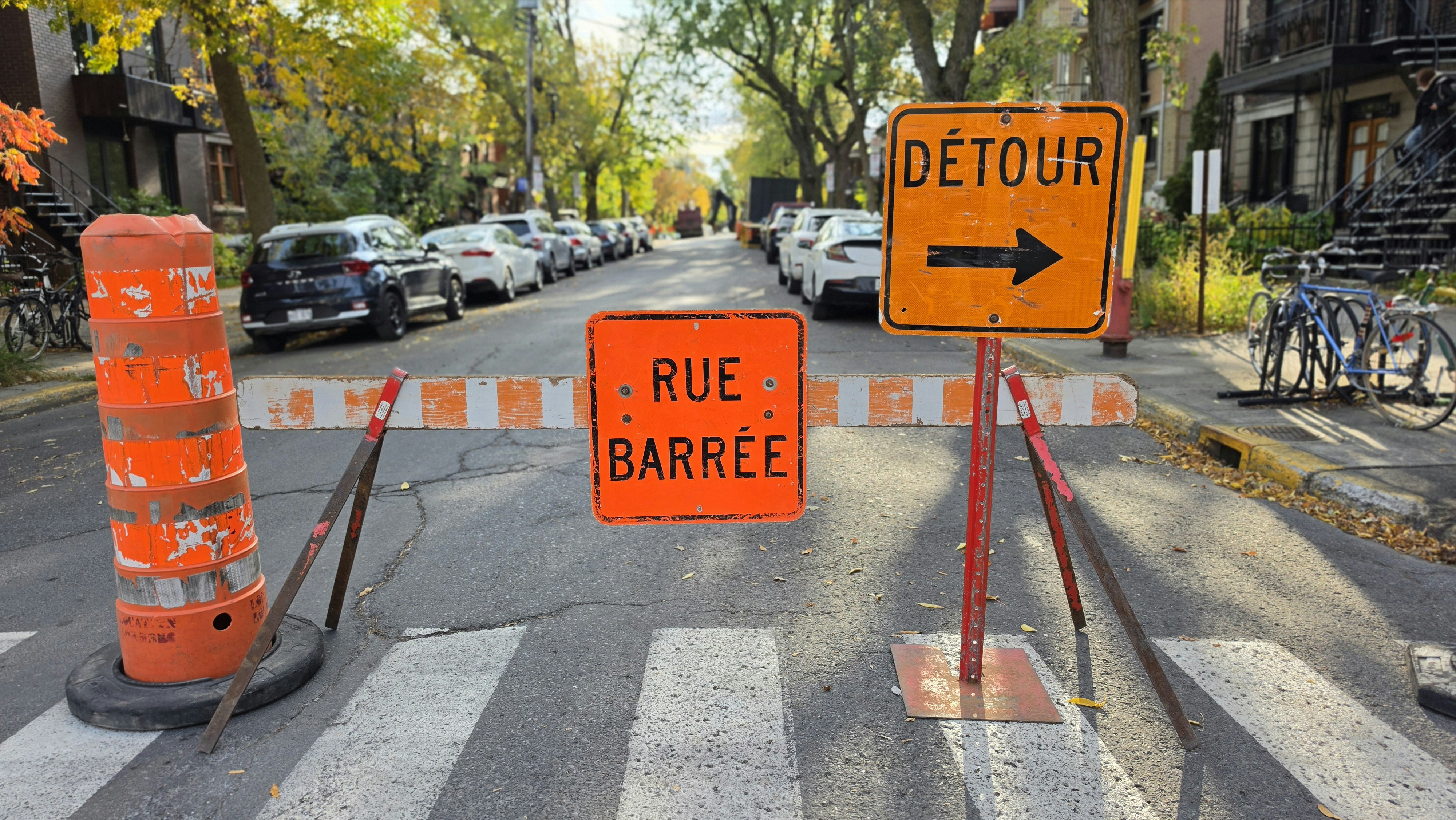 Crossing Under Construction: Orange Barricades Guard a Quiet City Block