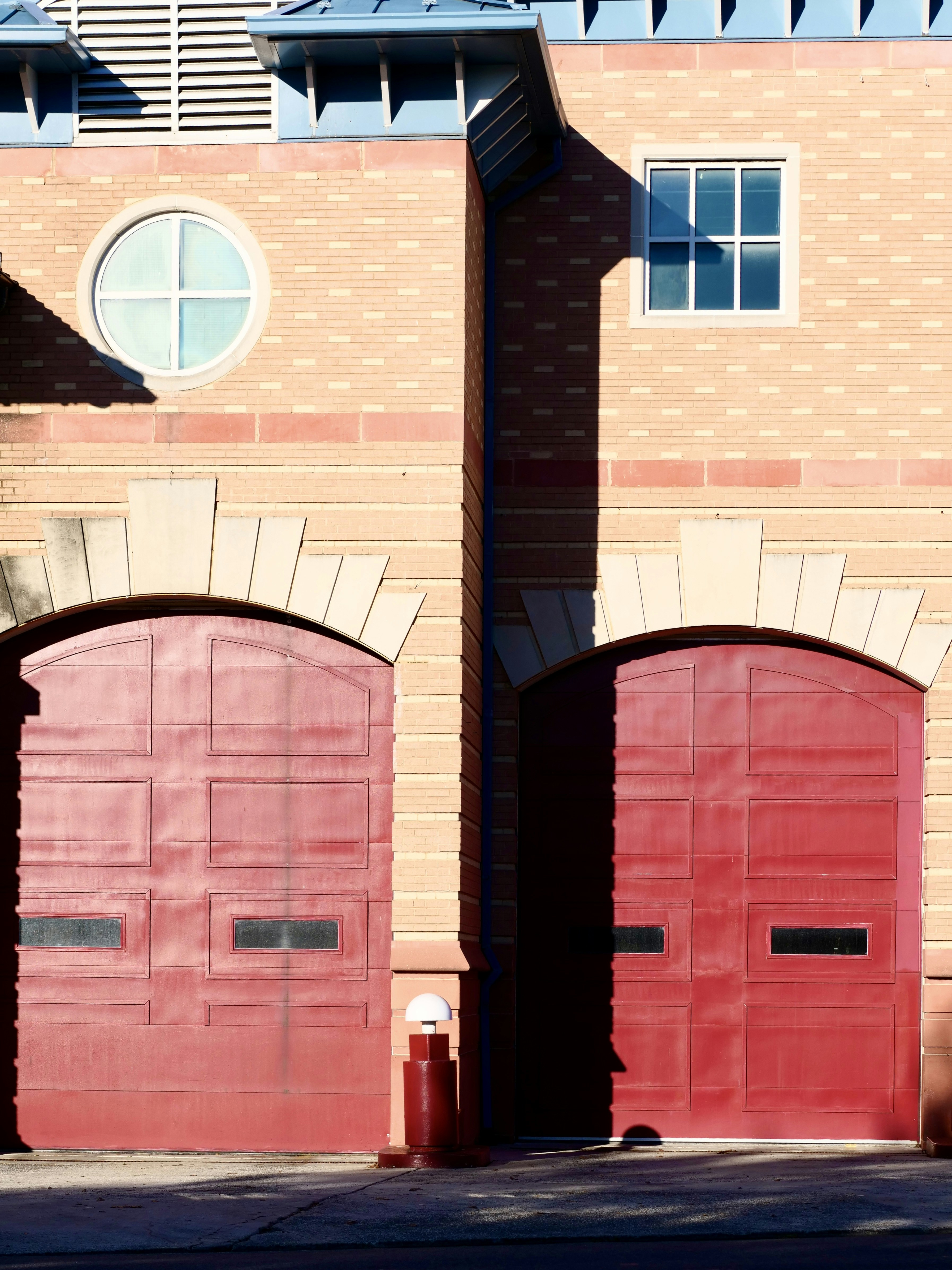 Two Red Doors Under Brick Arches: Symmetry and Shadowplay