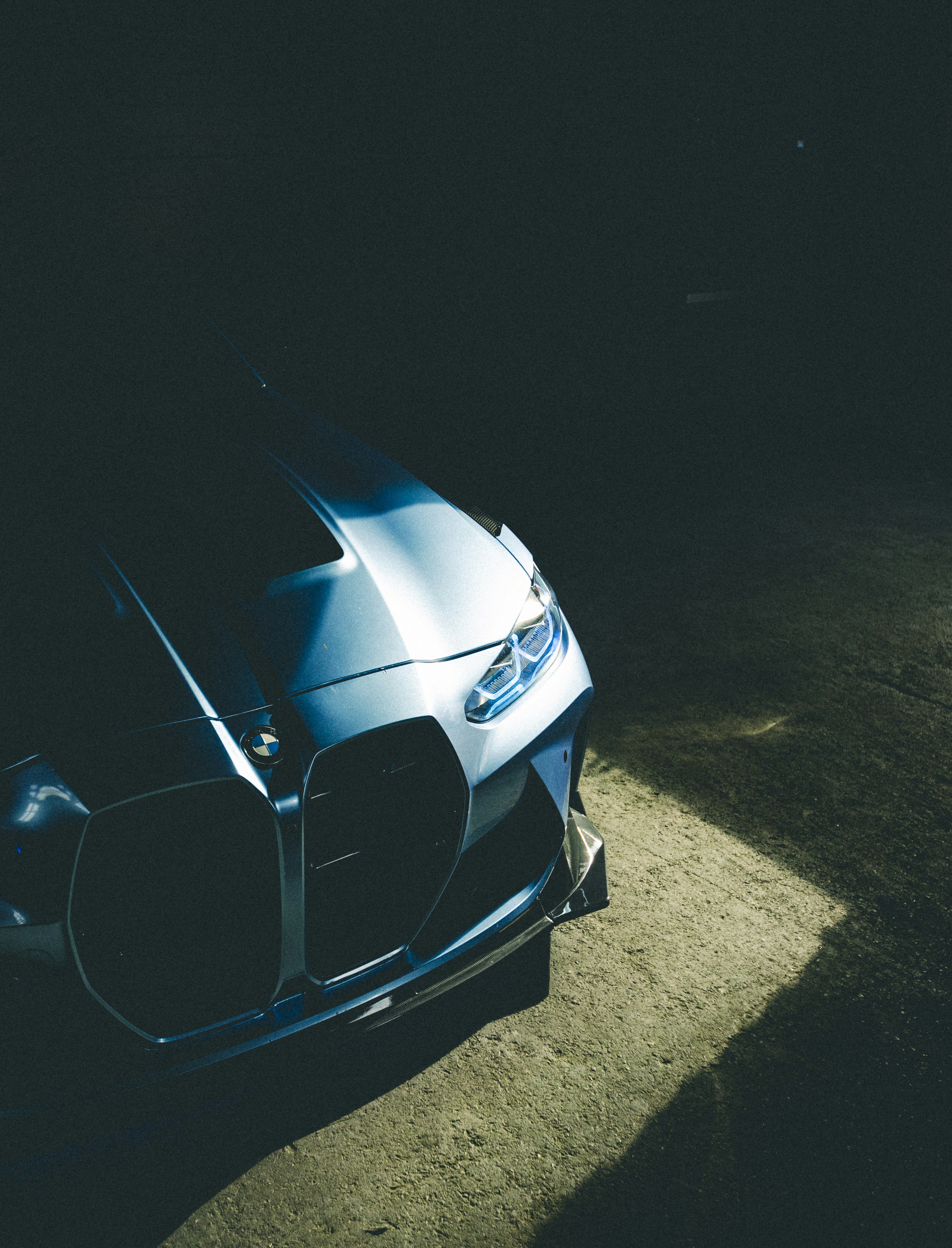 Midnight Alpine: A Blue BMW Dawns Under Streetlight Noir