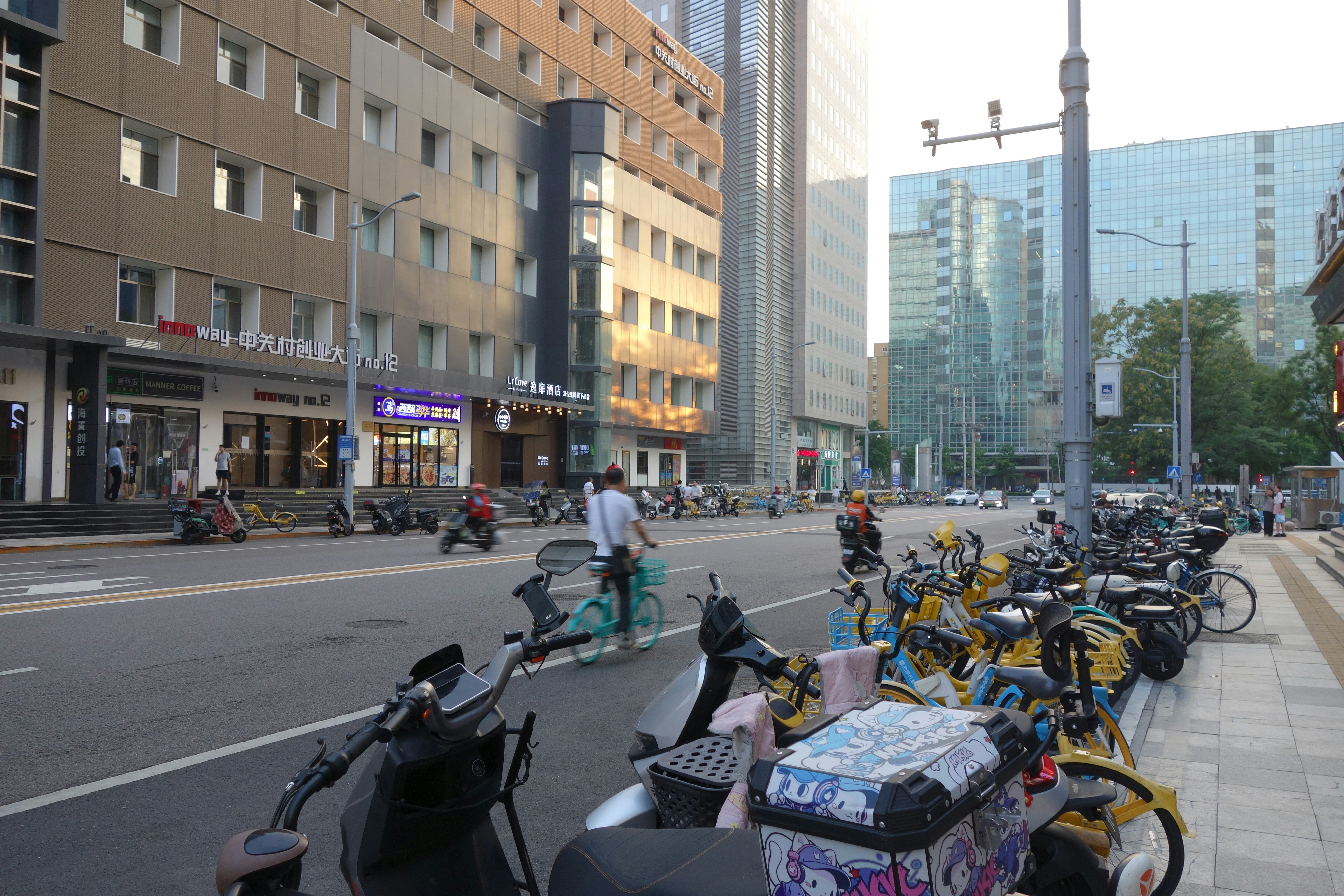 Urban Bedazzle: Bikes Line the Street with Glass Towers Rising Behind