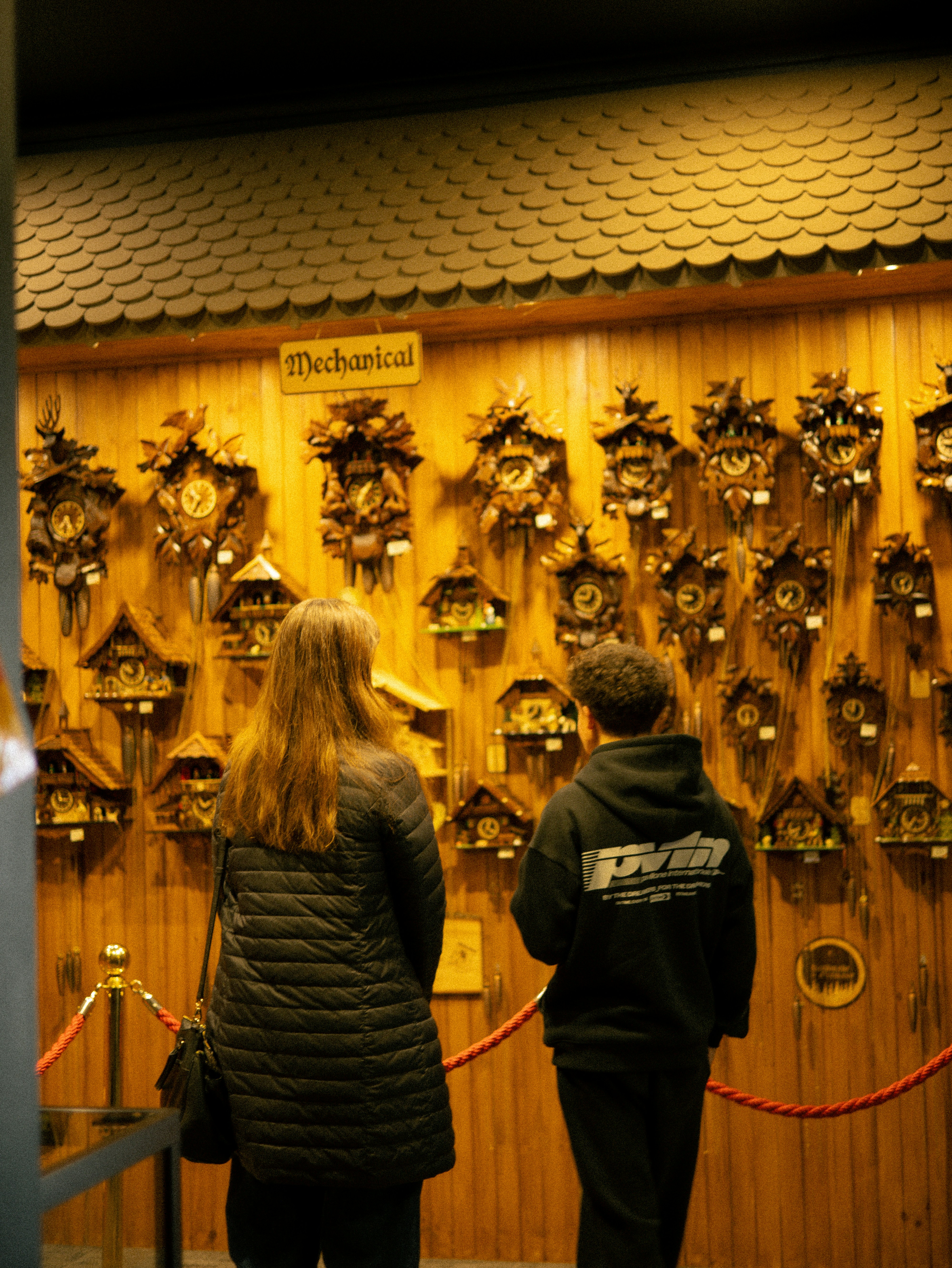 Two visitors in a warm museum of clocks