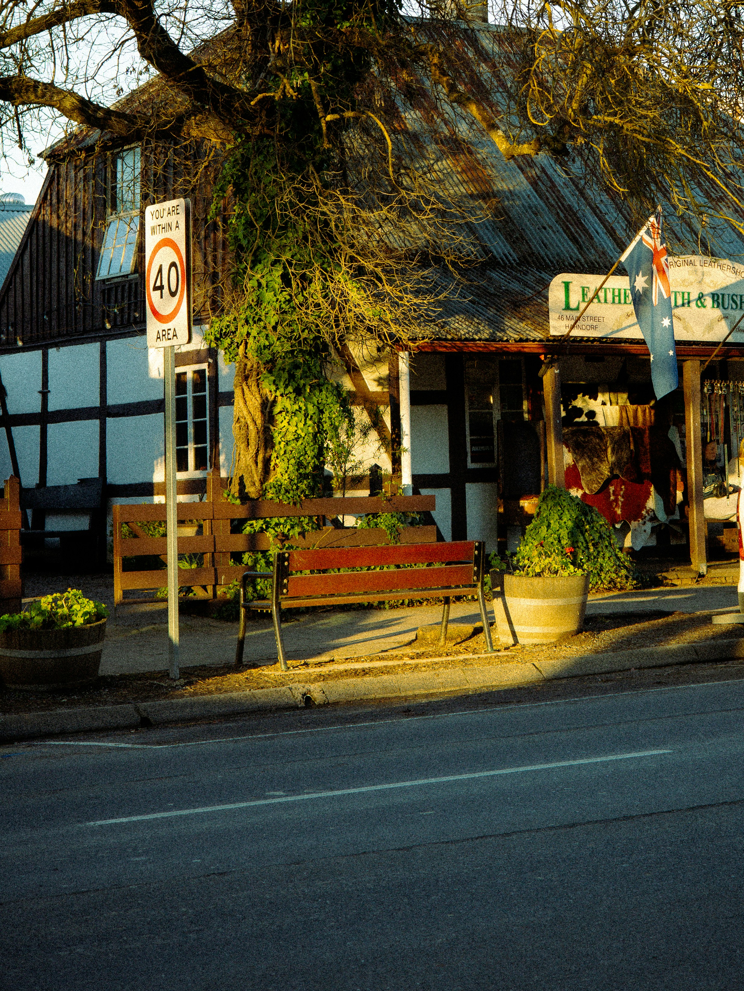 Sunlit storefront on a quiet street with a rustic charm