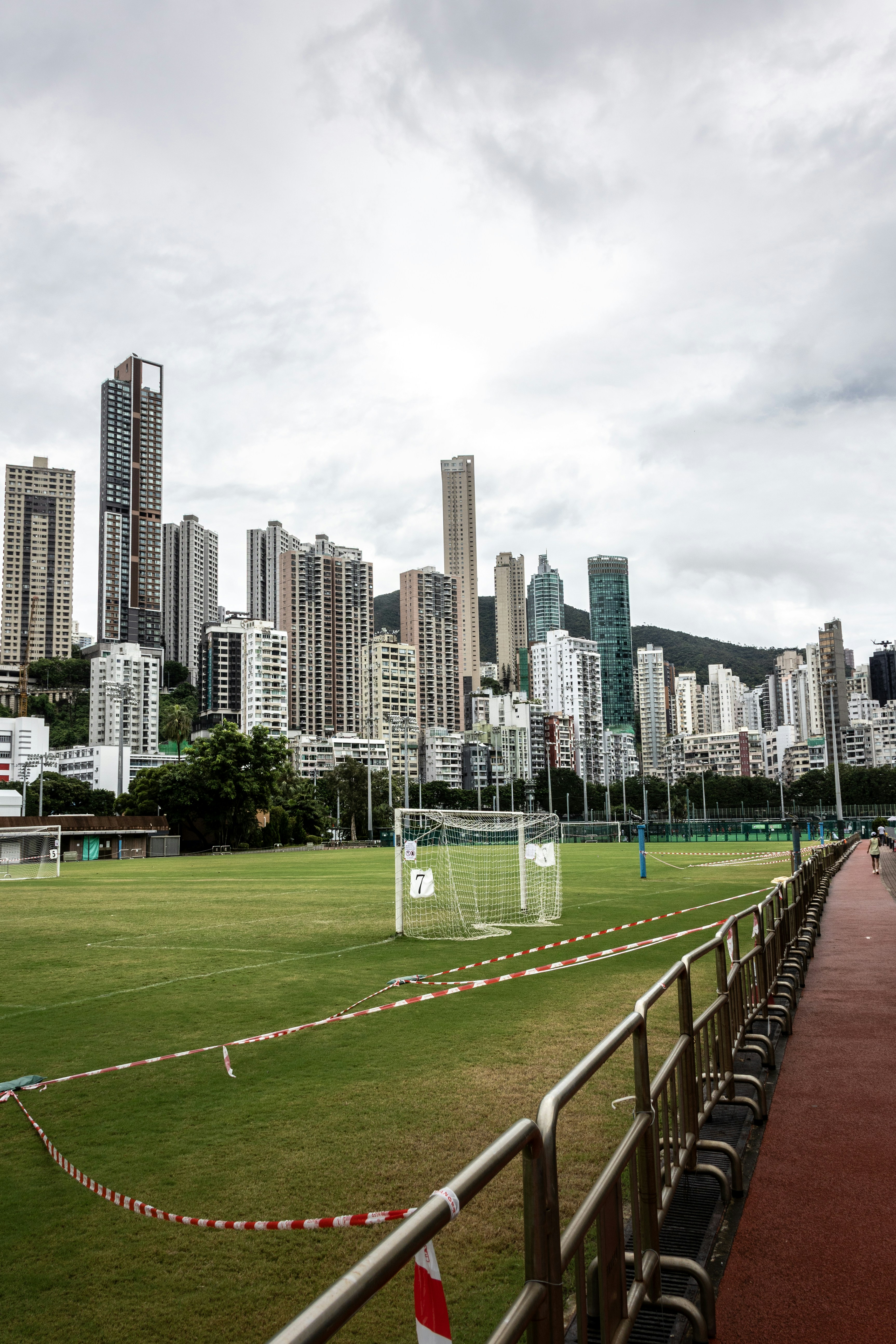 Urban Horizon over a Park: Skyline Framed by a Perimeter Track