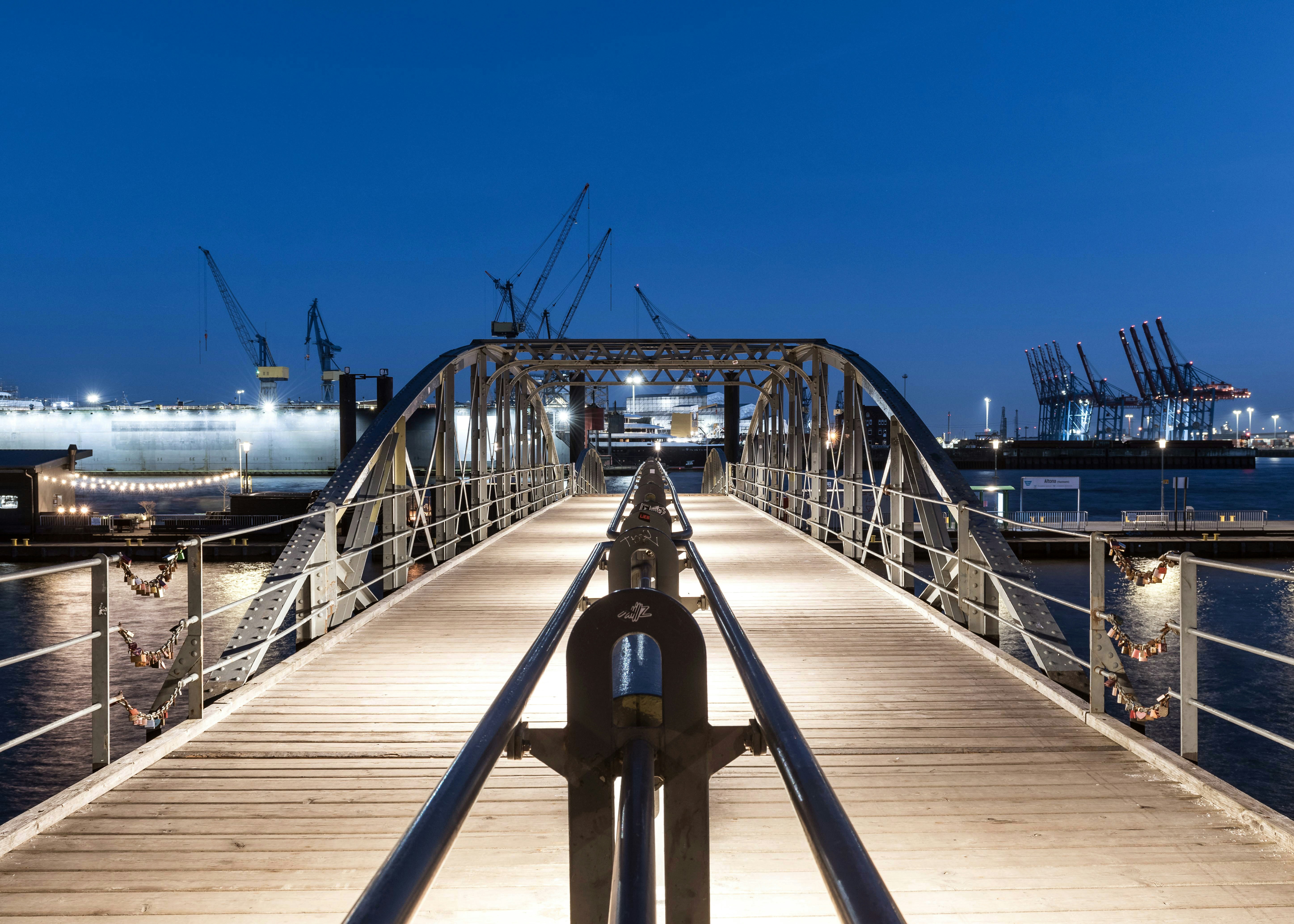 Urban Pier at Dusk: A Symmetrical Walkway into the Harbor Lights