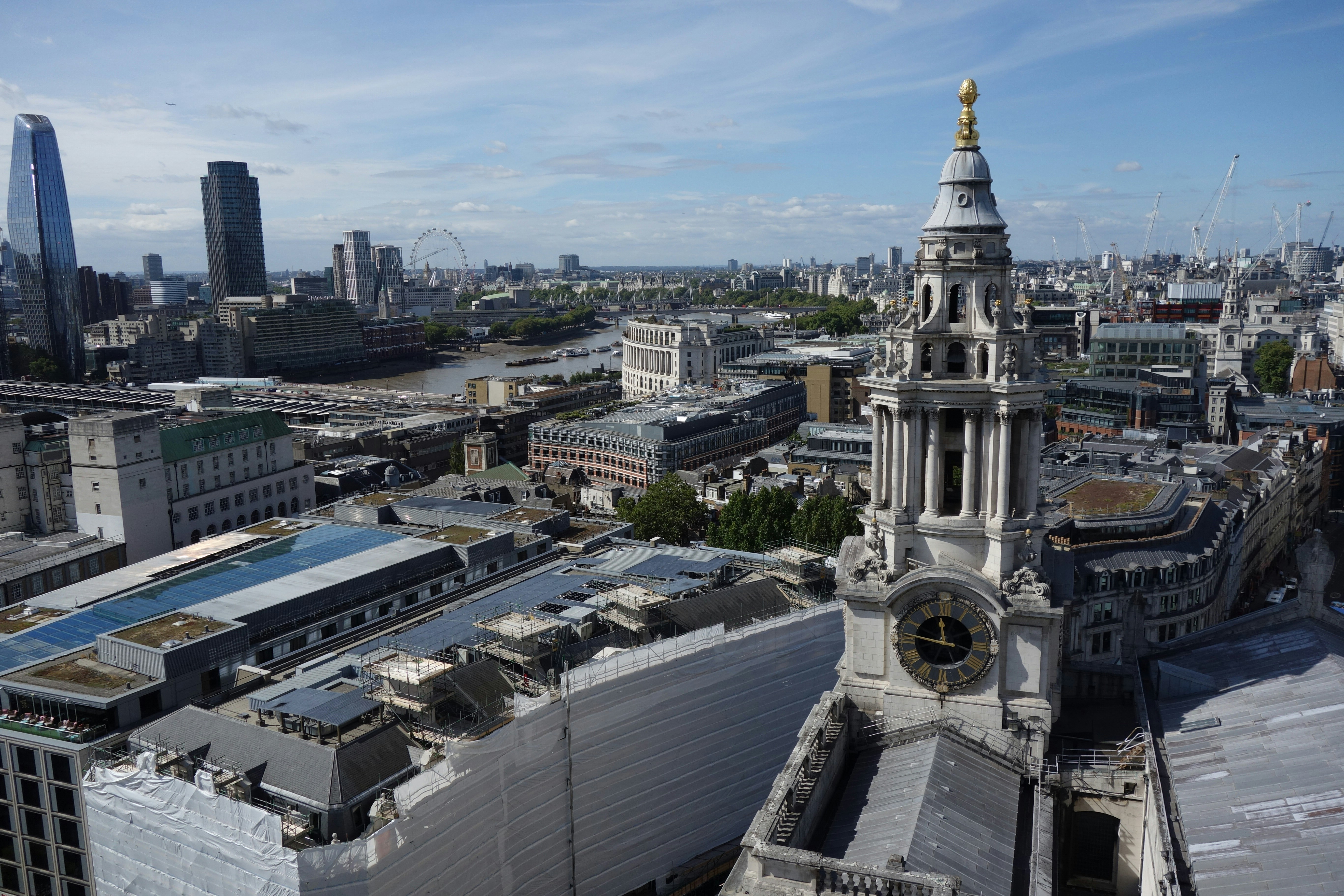 Towering Clockscape: A Rooftop View Over a Modernized Riverfront