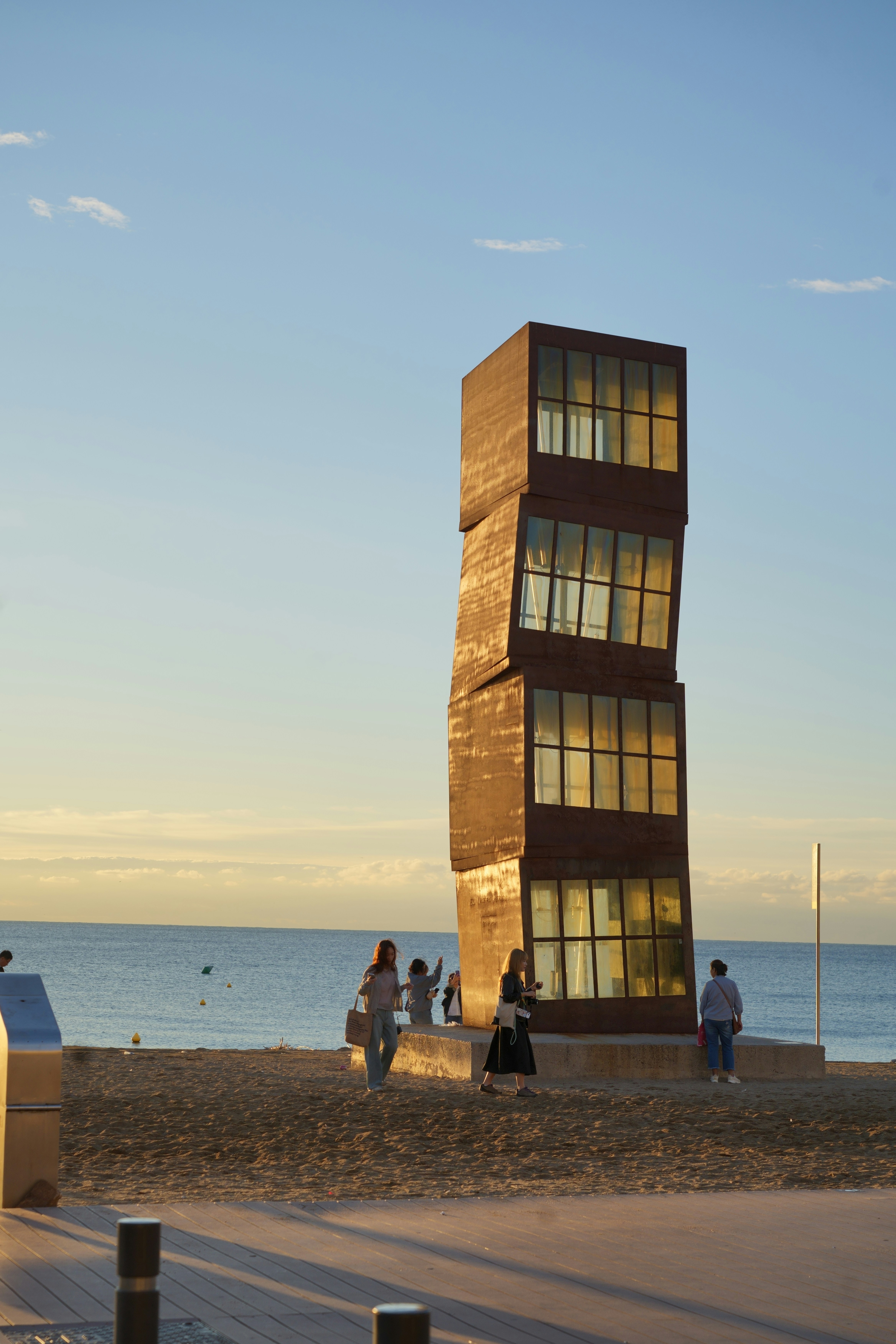 Tilted Stack by the Sea: Sunlit Geometry and Quiet Beach