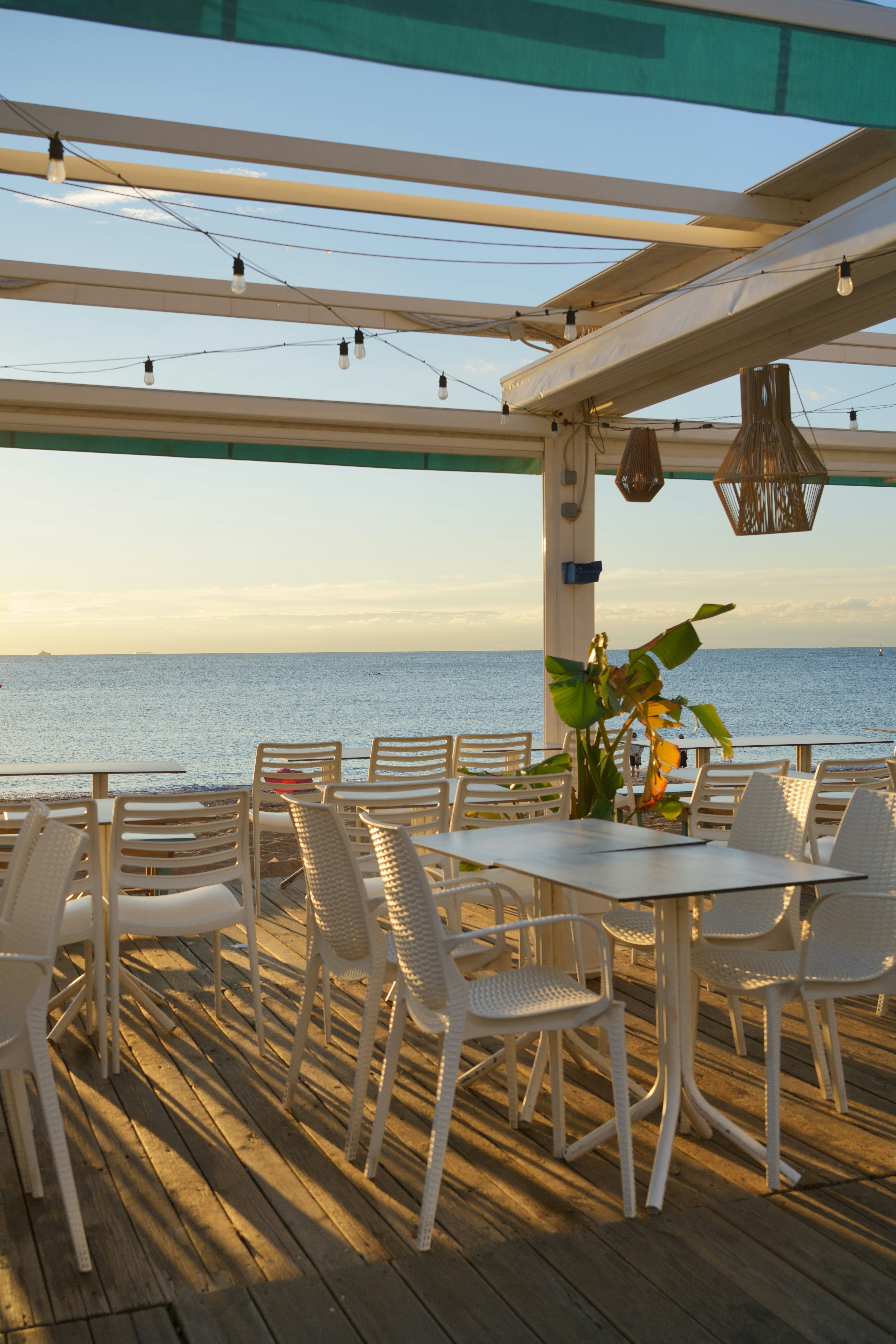Seaside Bistro Under String Lights at Golden Hour