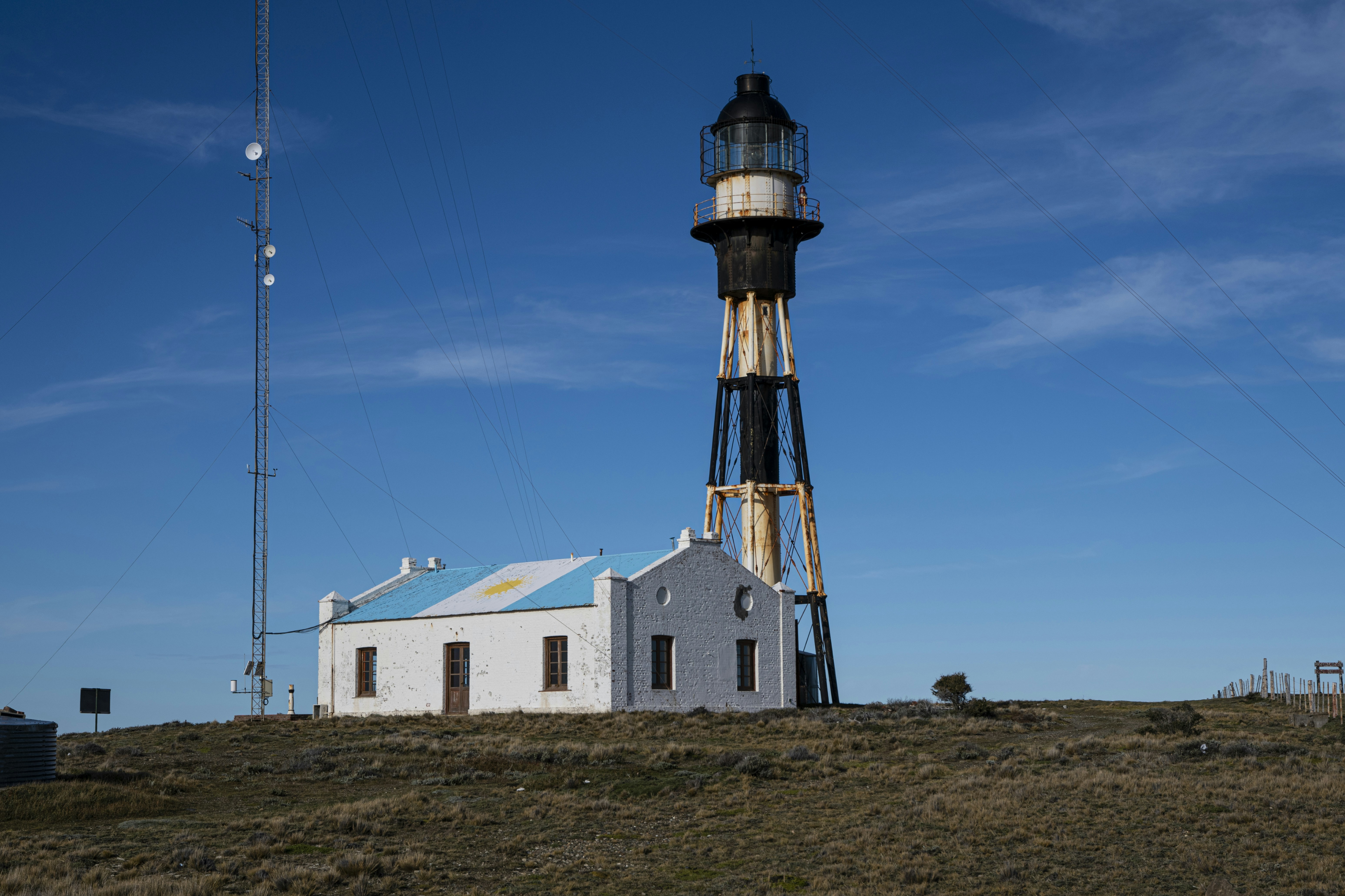 Beacon in the Quiet Moor: A Weathered Lighthouse Under a Clear Sky