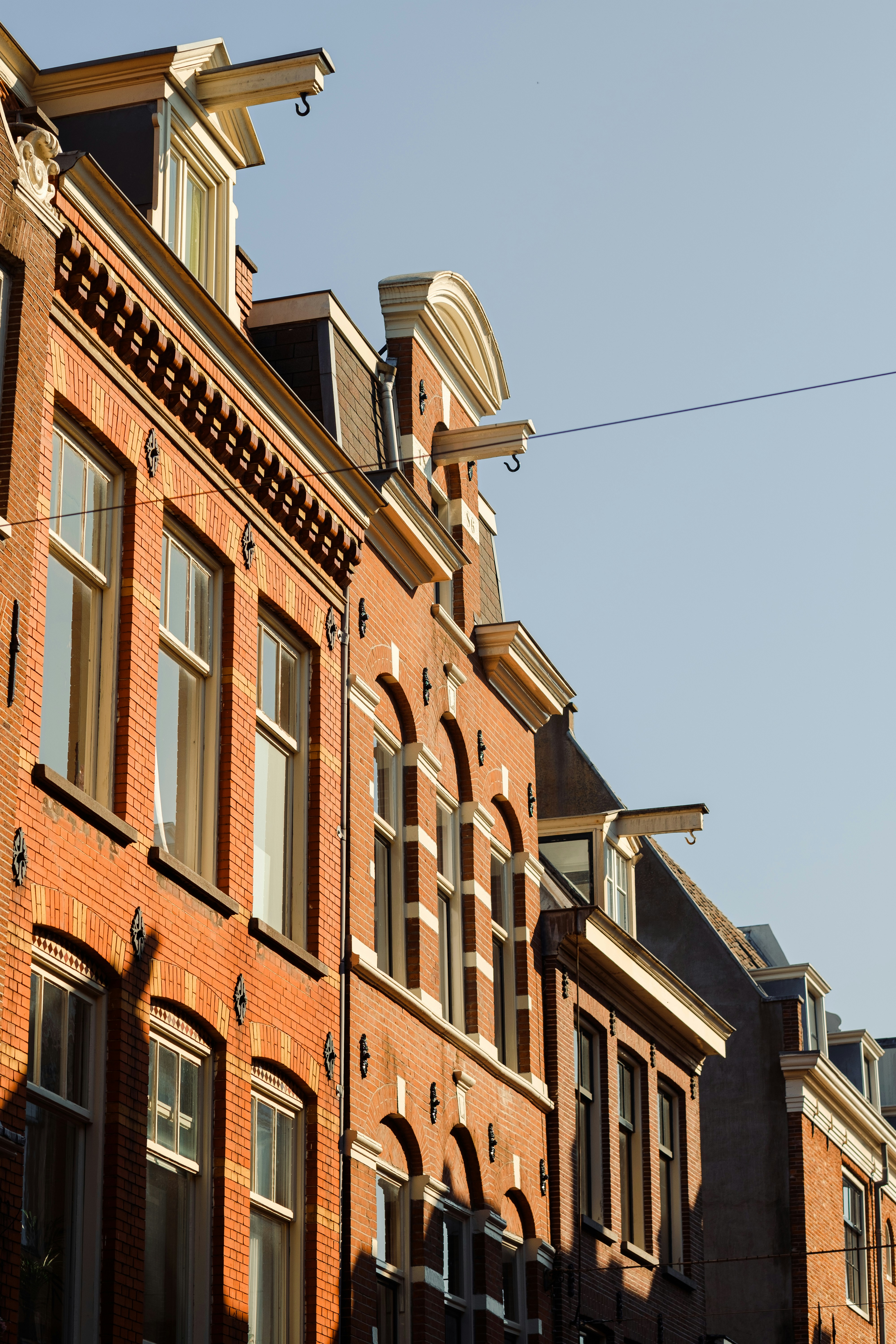 Sunlit Brick Facade: Corner of a Historic Dutch-Style Street