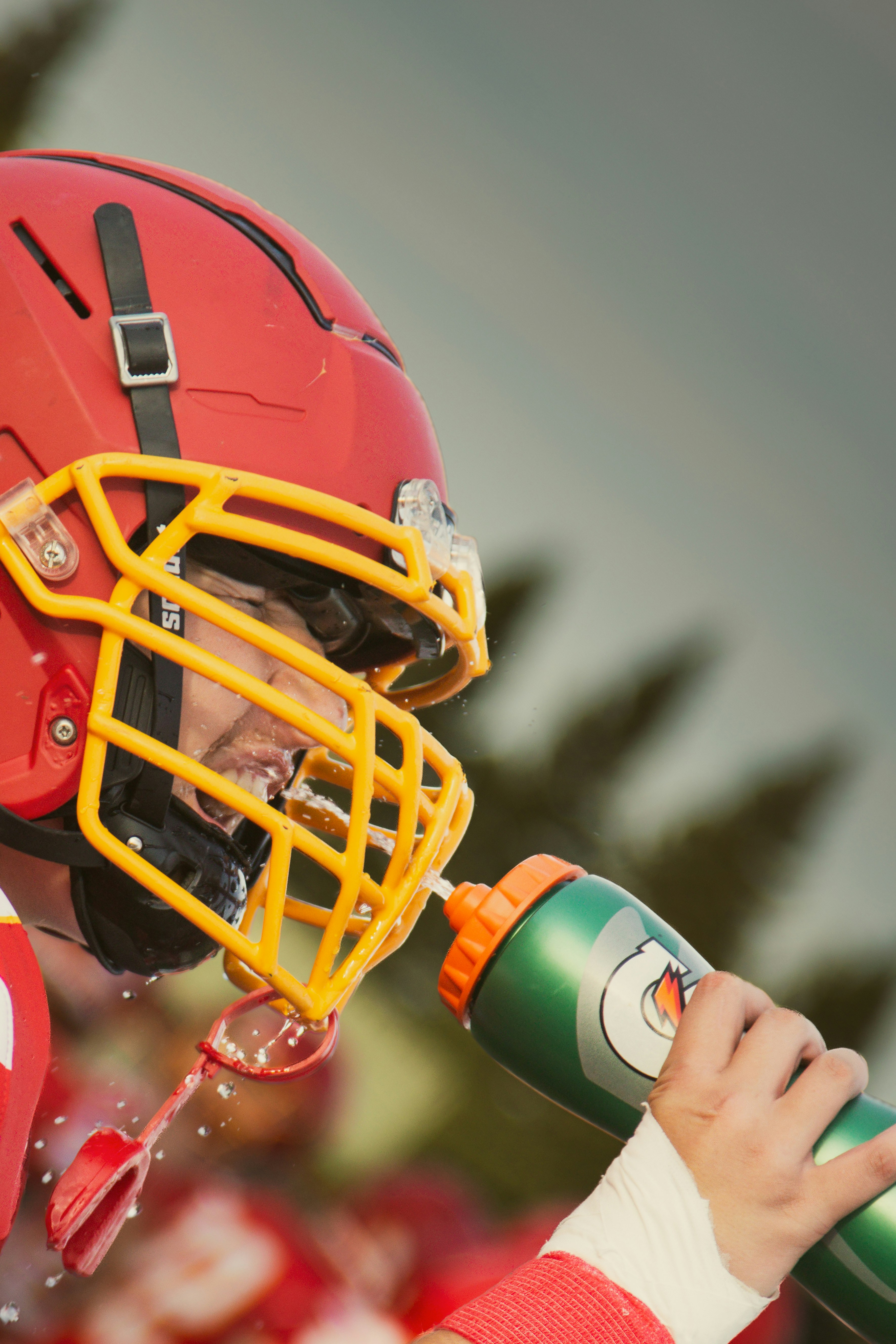 Red Helm, Green Sip: A Quick Hydration Break on the Field