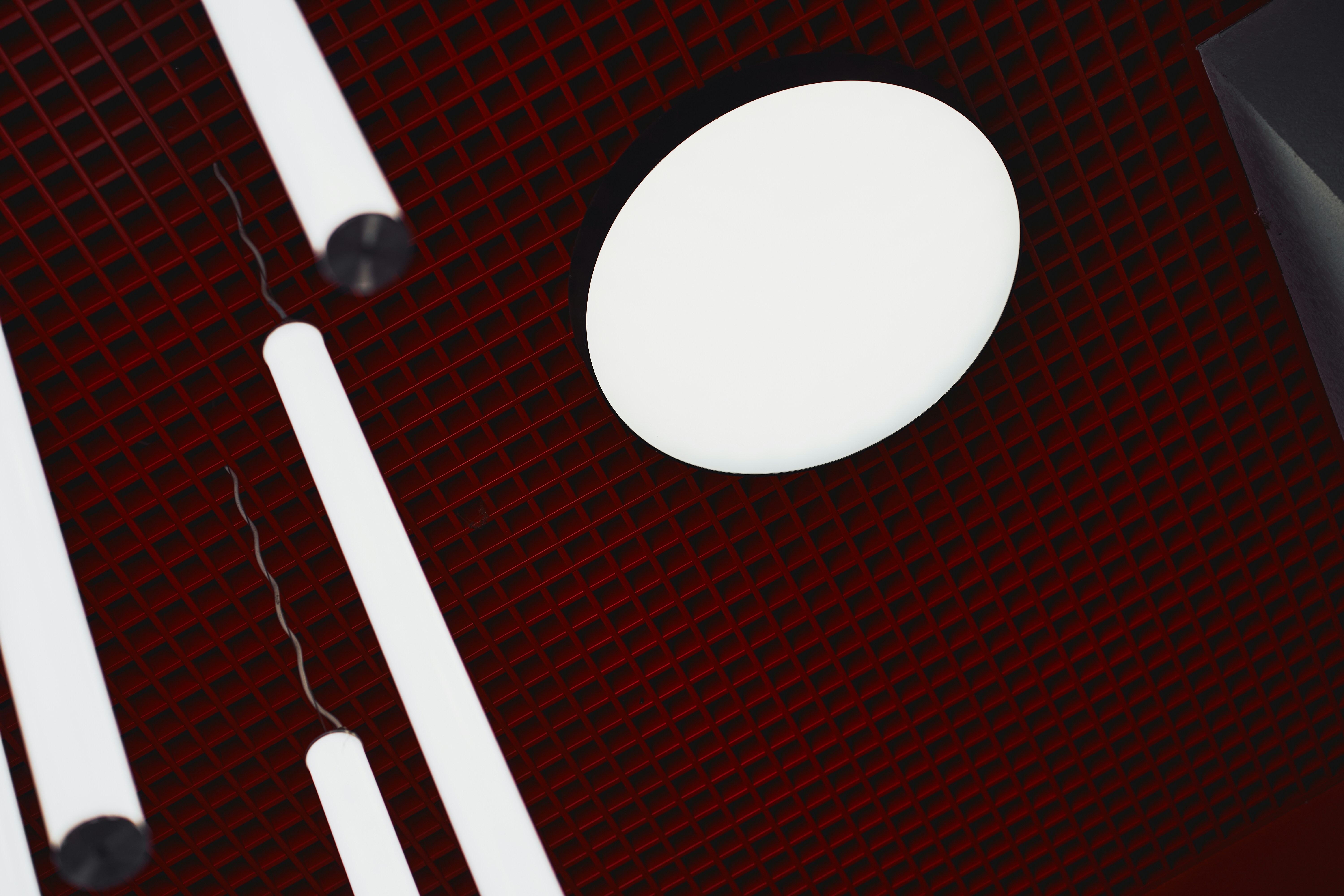Red Grid and Oval Glow: Abstract Light on a Patterned Surface