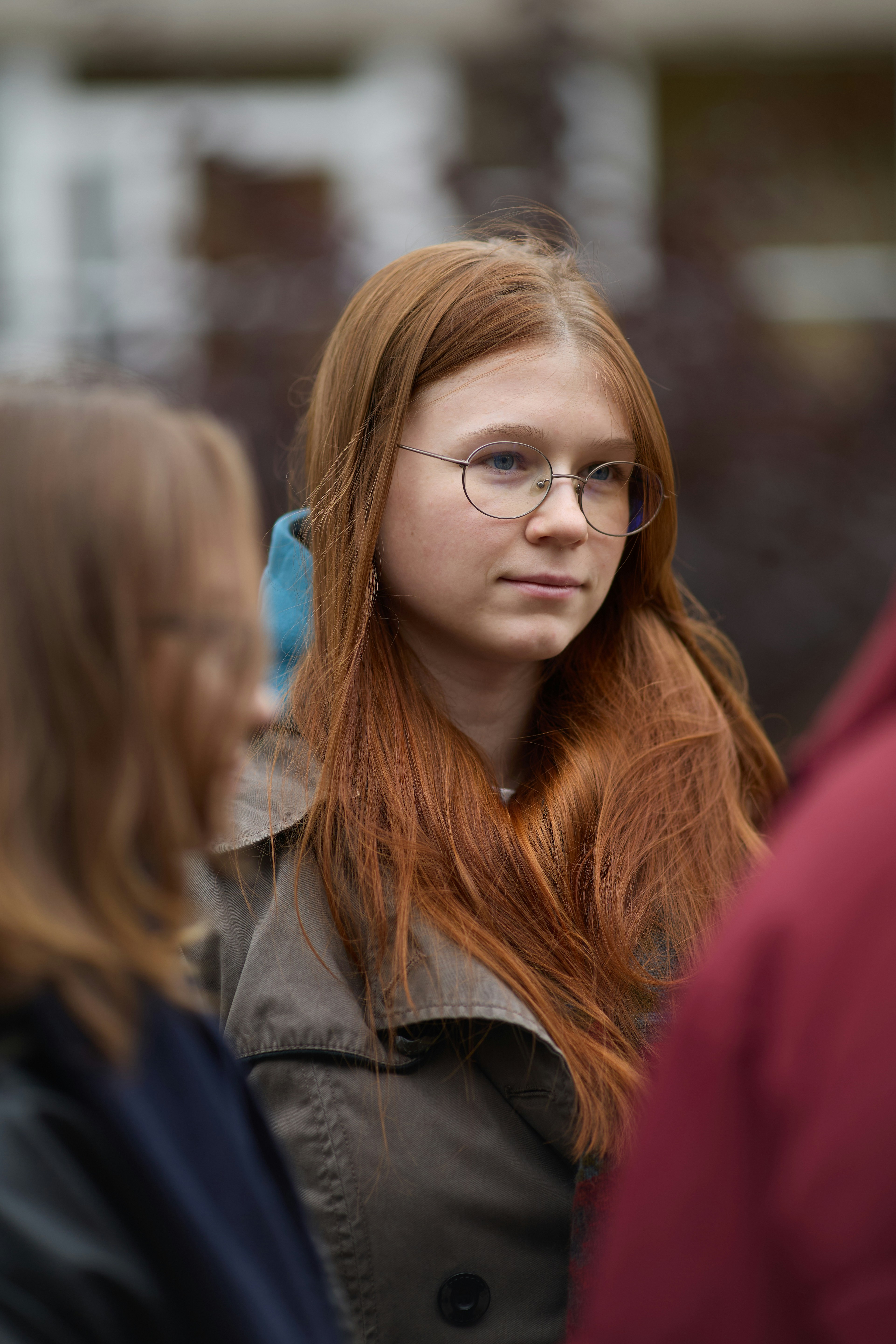 Quiet Confidence: A Portrait in Soft Focus Ringed by Red Hair