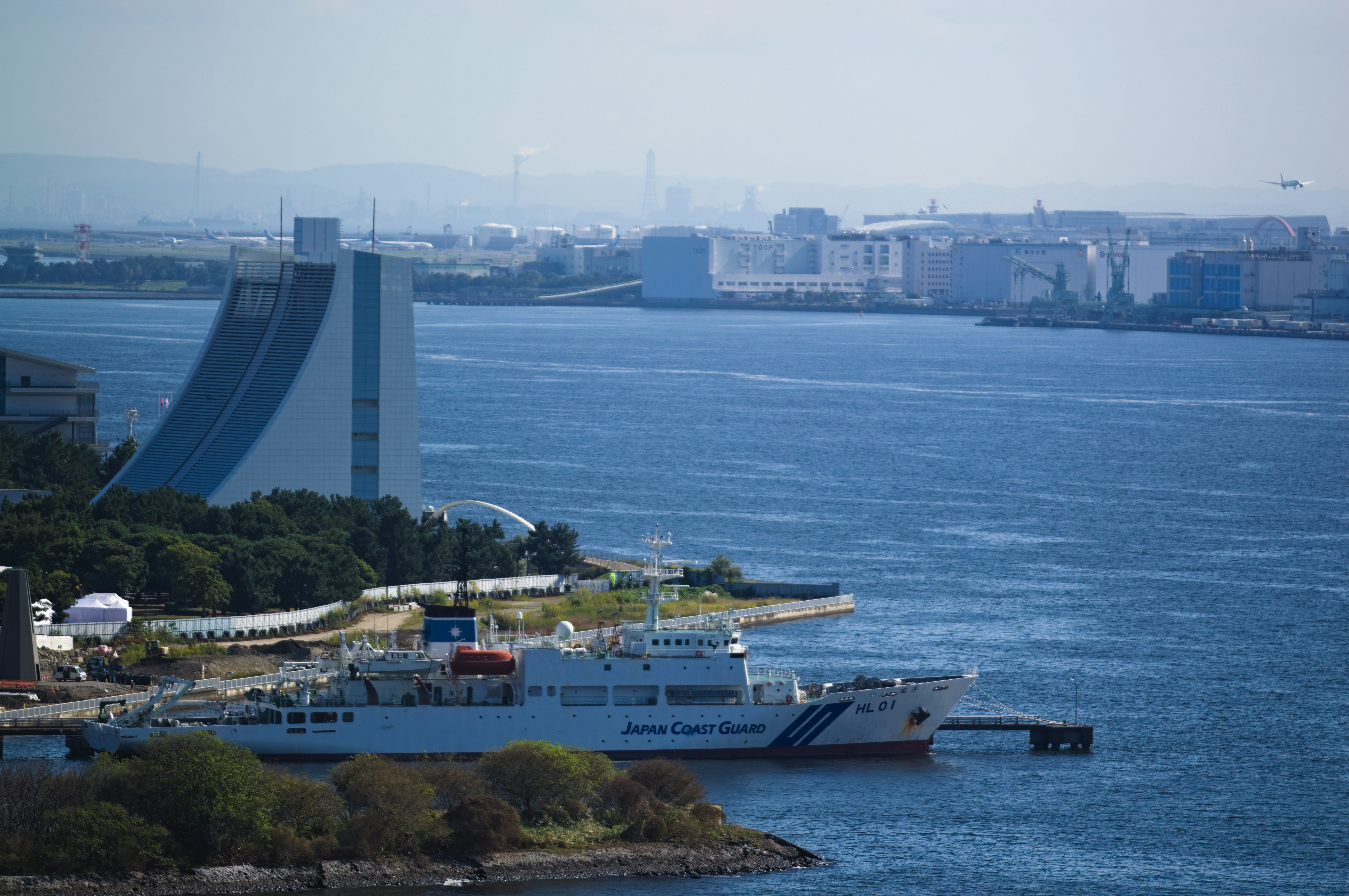 Harbor Geometry: The Curved Breakwater and Coastal Vessel