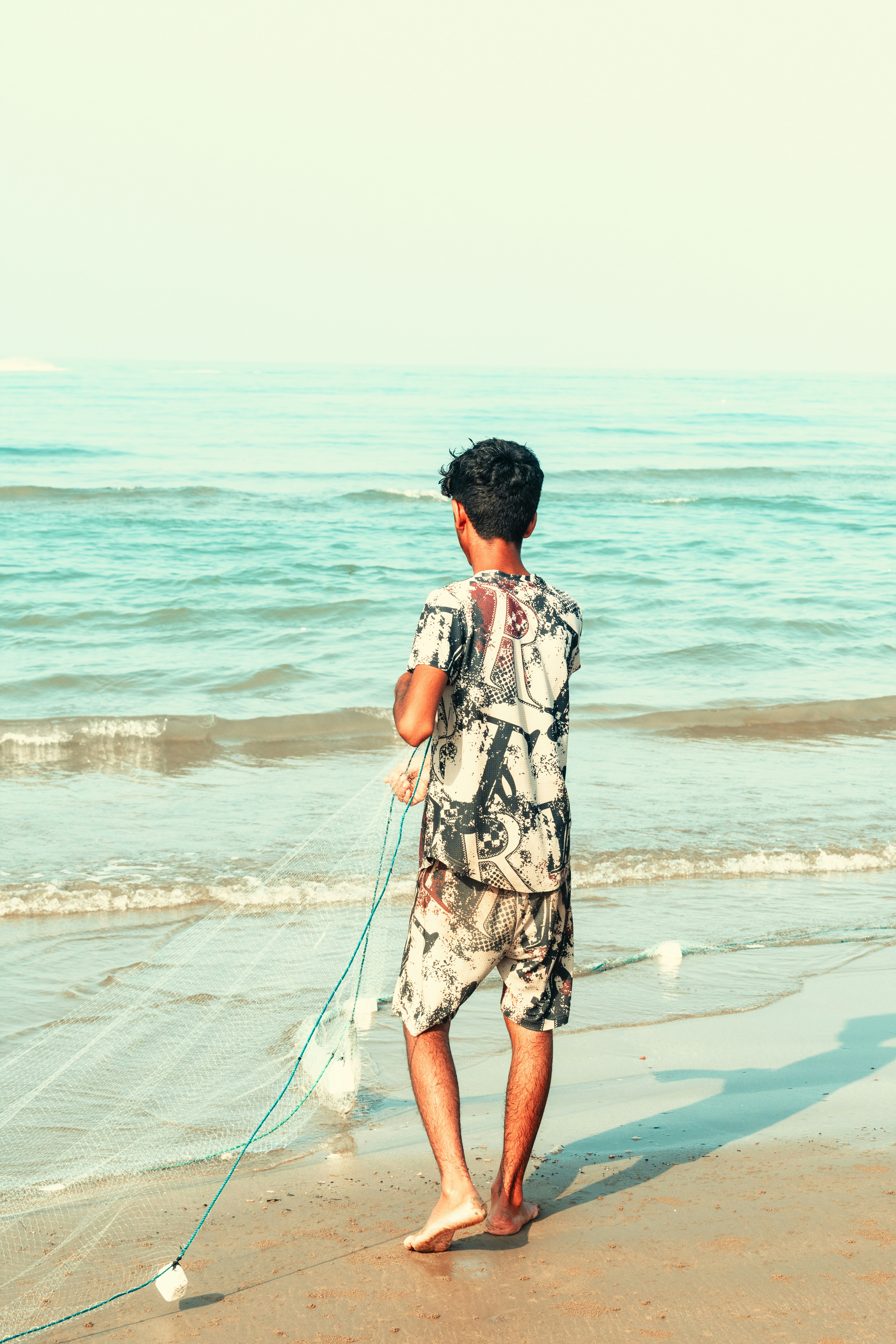 Lone Kite Footsteps: A Surfer’s Quiet Moment at Dusk Beach