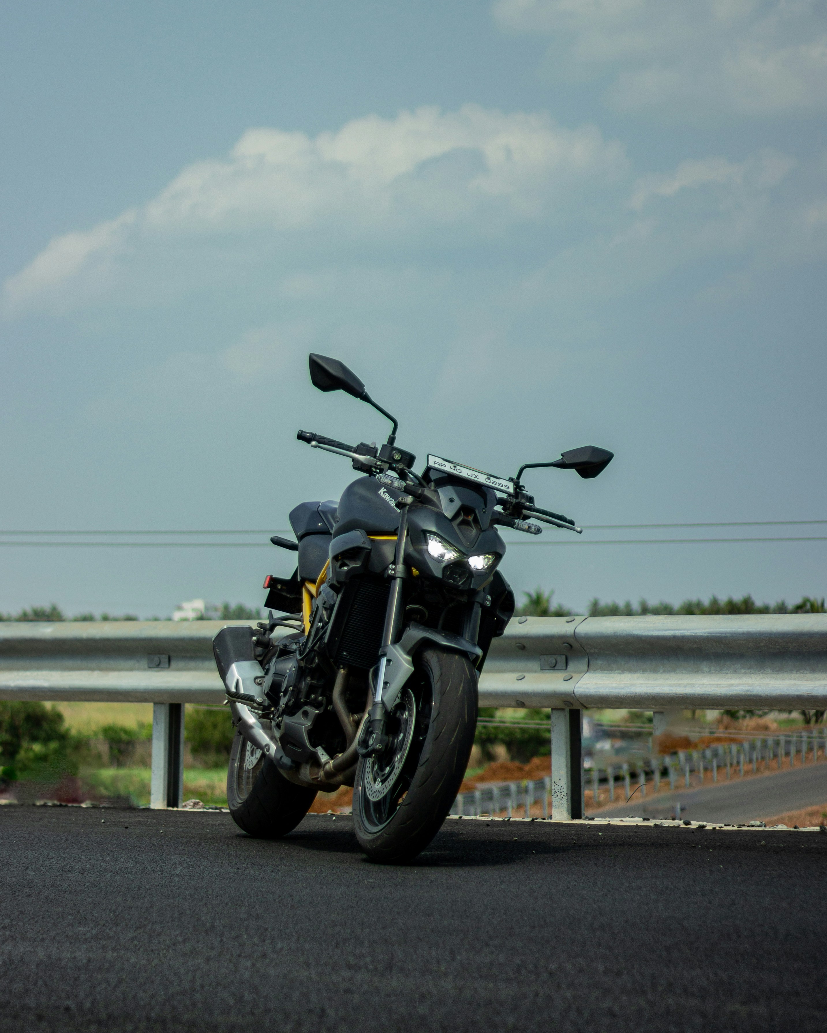 Dark Stallion on the Asphalt: A Motorcycle Guarded by Rails