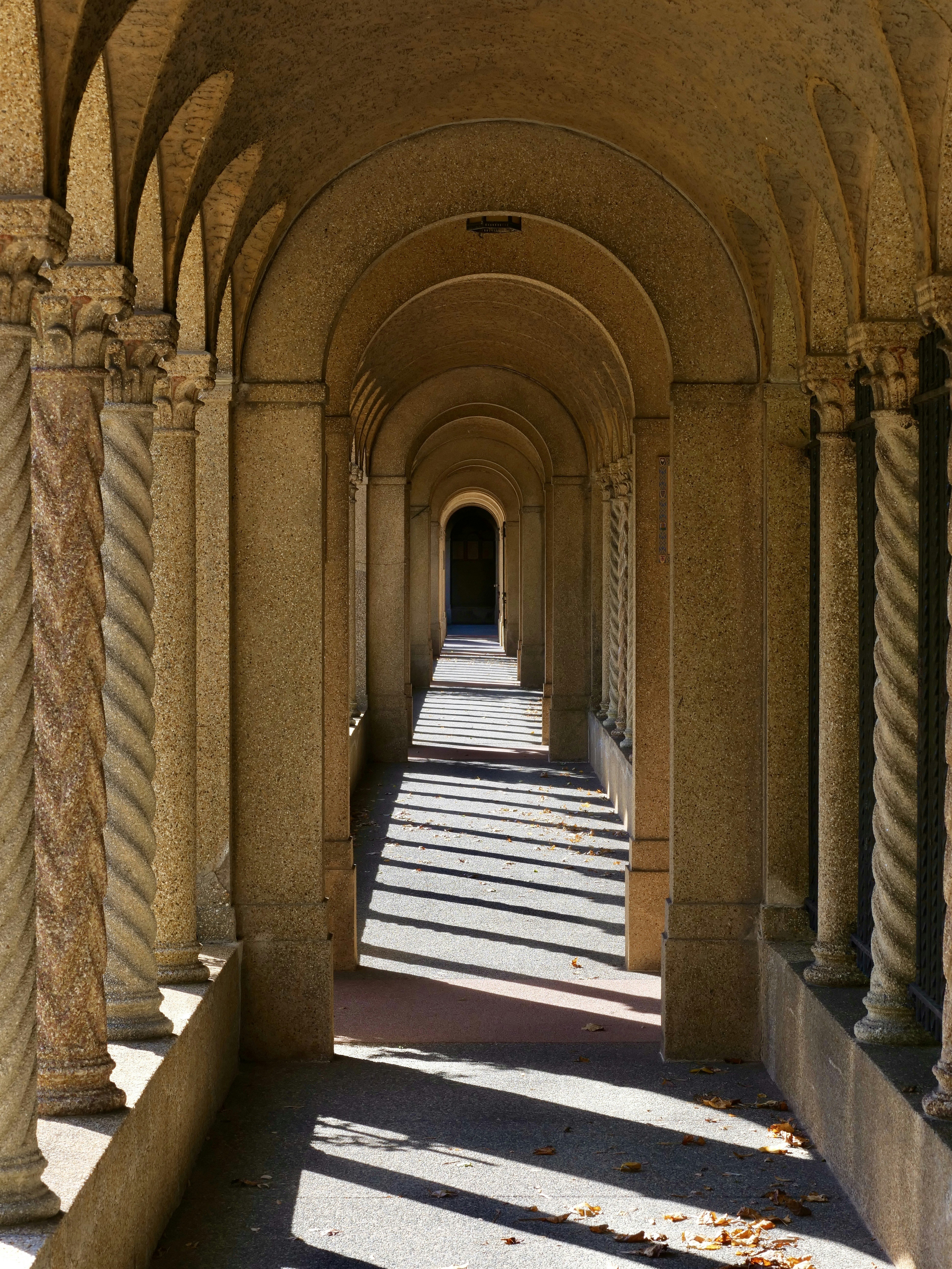 Line of Vaulted Light: Archway Corridor Receding into Darkness