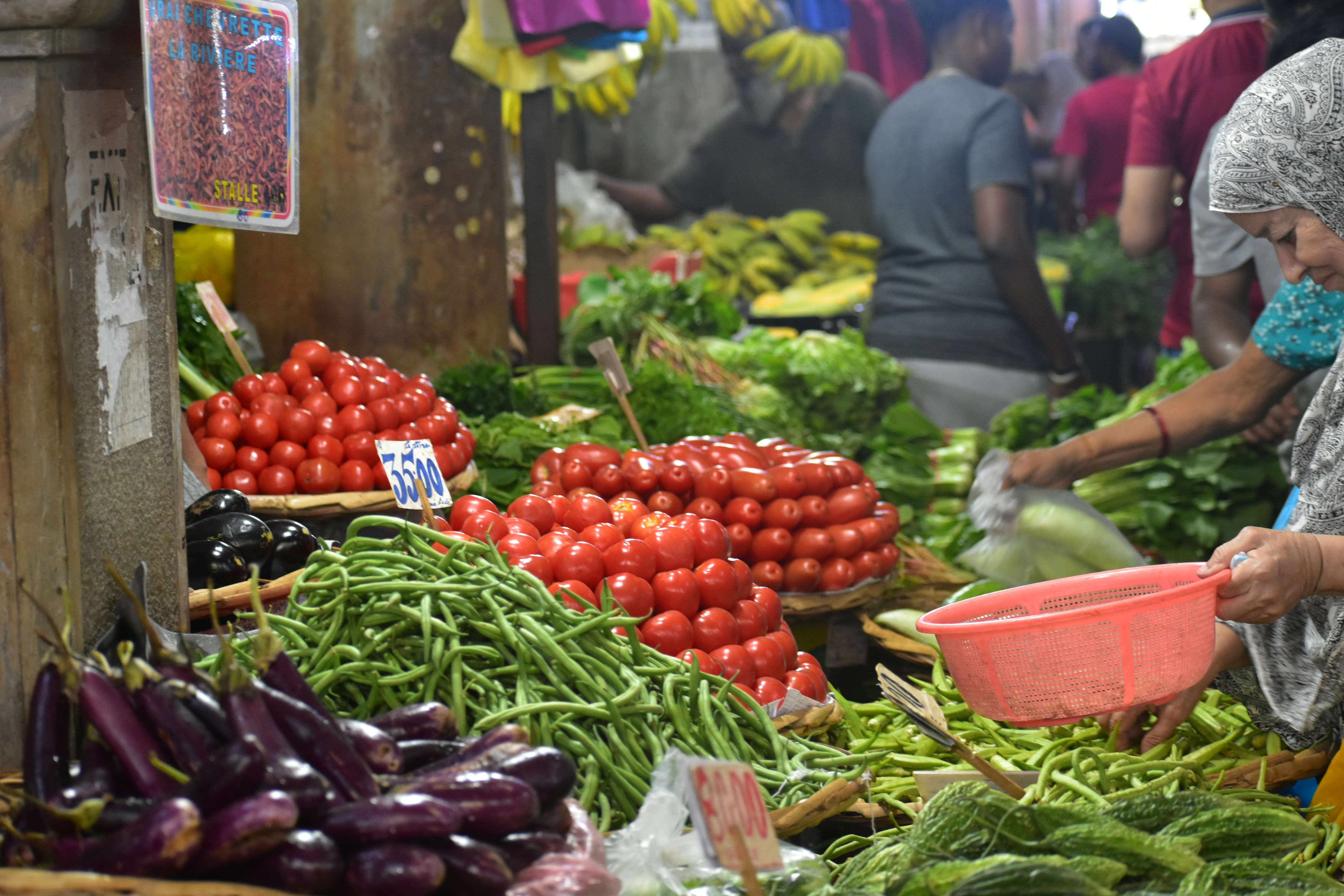 Market Harvest: Tomatoes, peppers, and greens at a bustling roadside stall