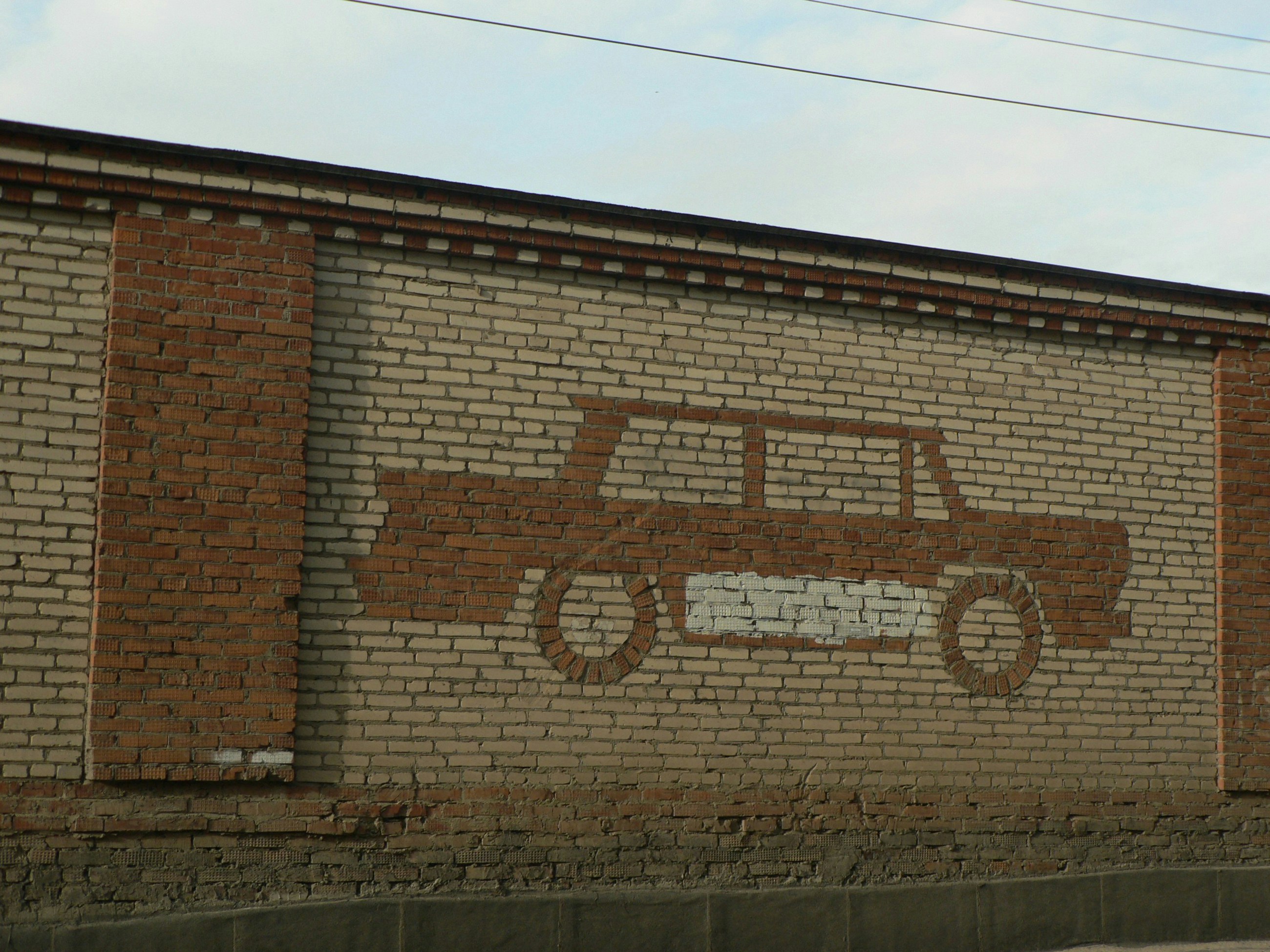 Graffiti Car on Weathered Brick Wall