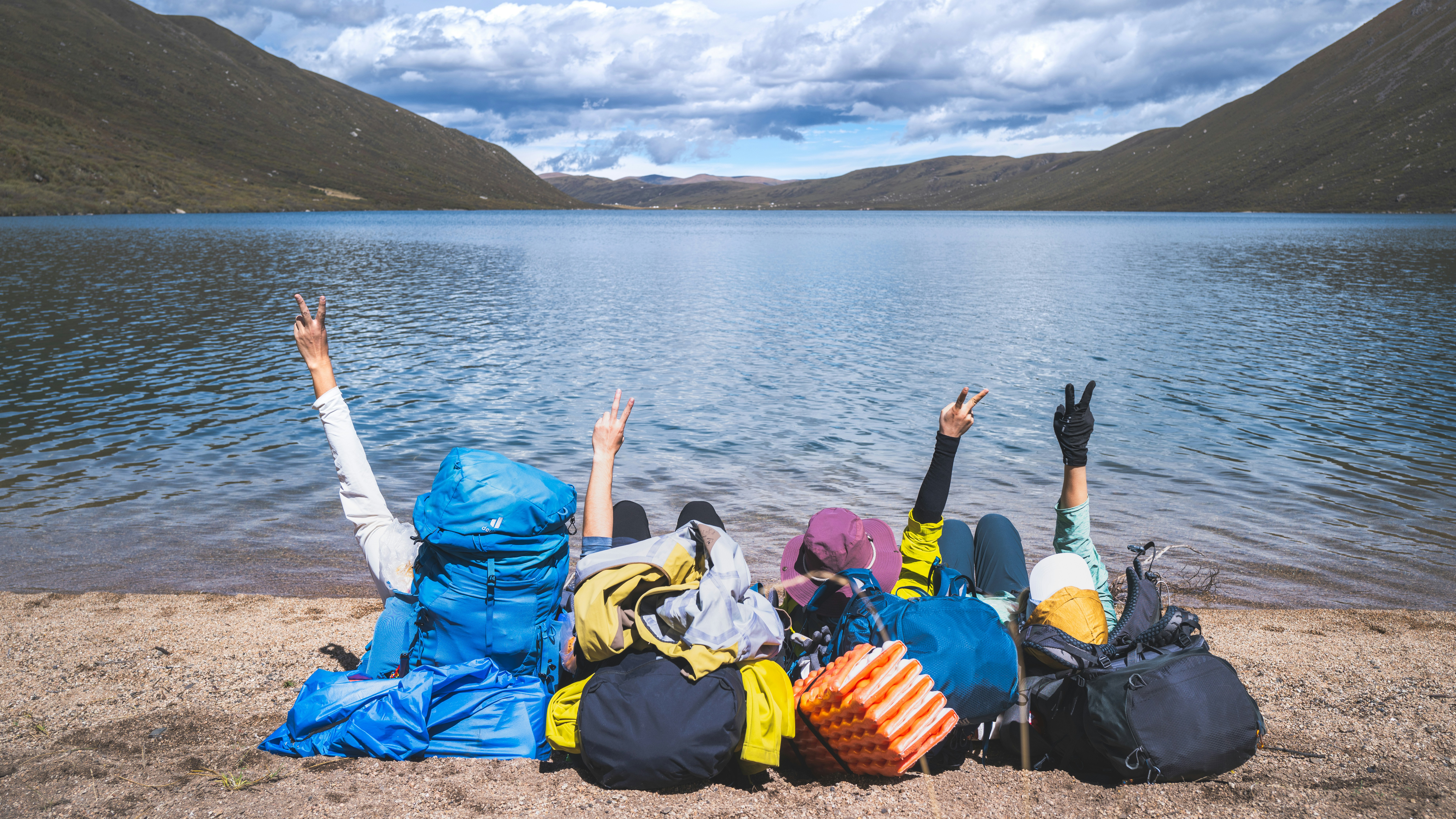 Six Backpackers Resting by a Mountain Lake