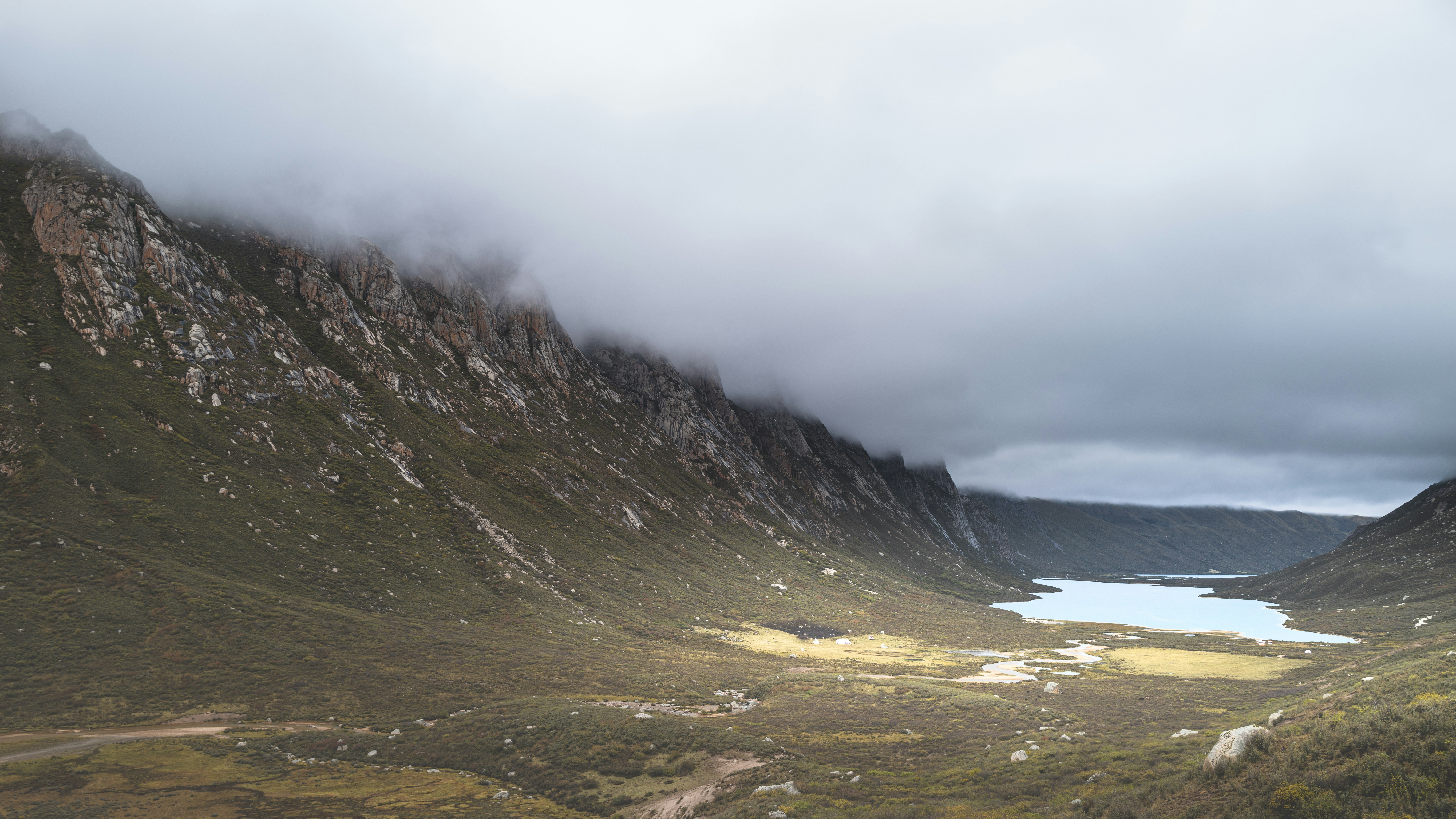 Shallow mist over a windswept valley carved by a braided river