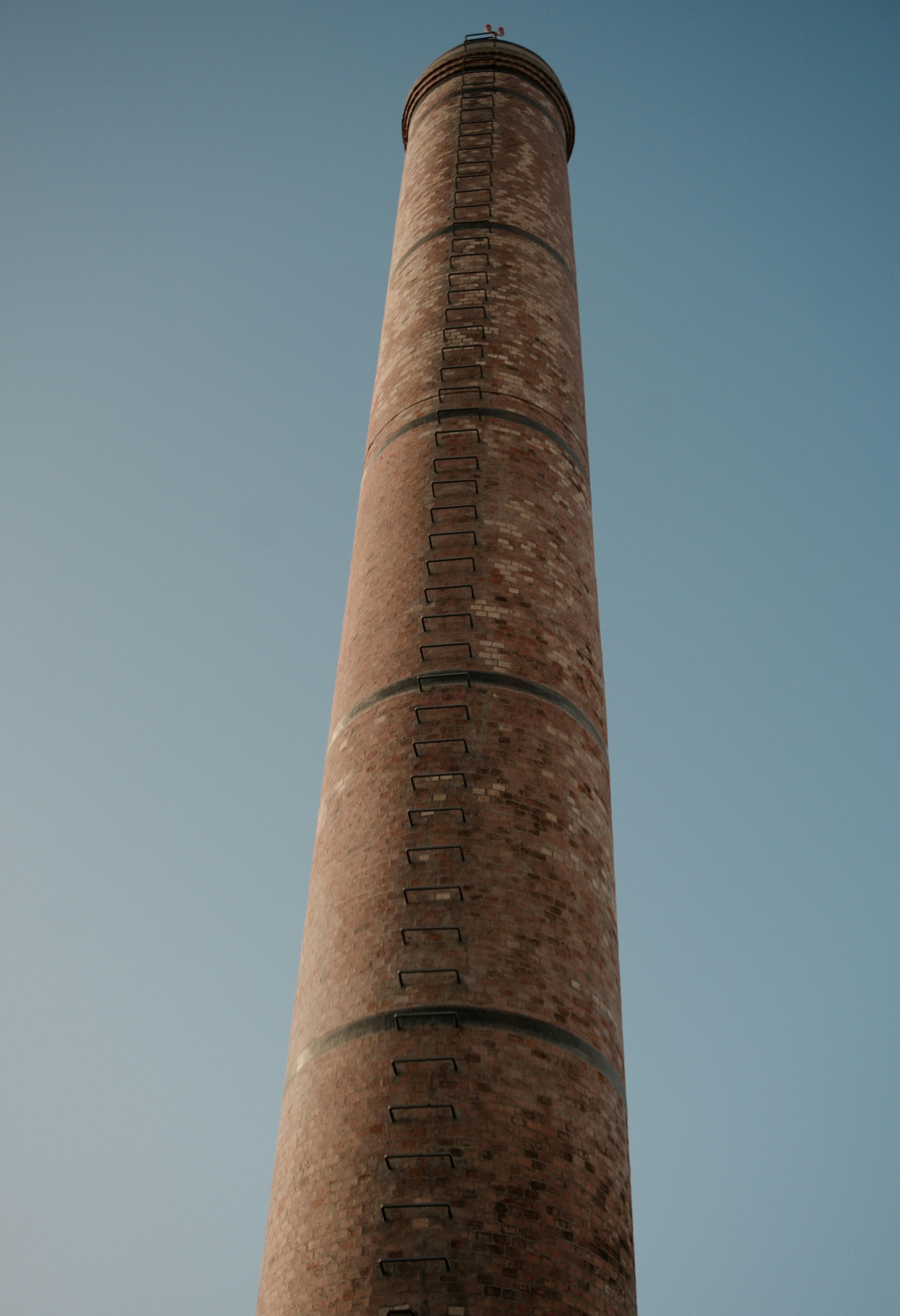 Brick Chimney Reaching Toward a Clear Sky