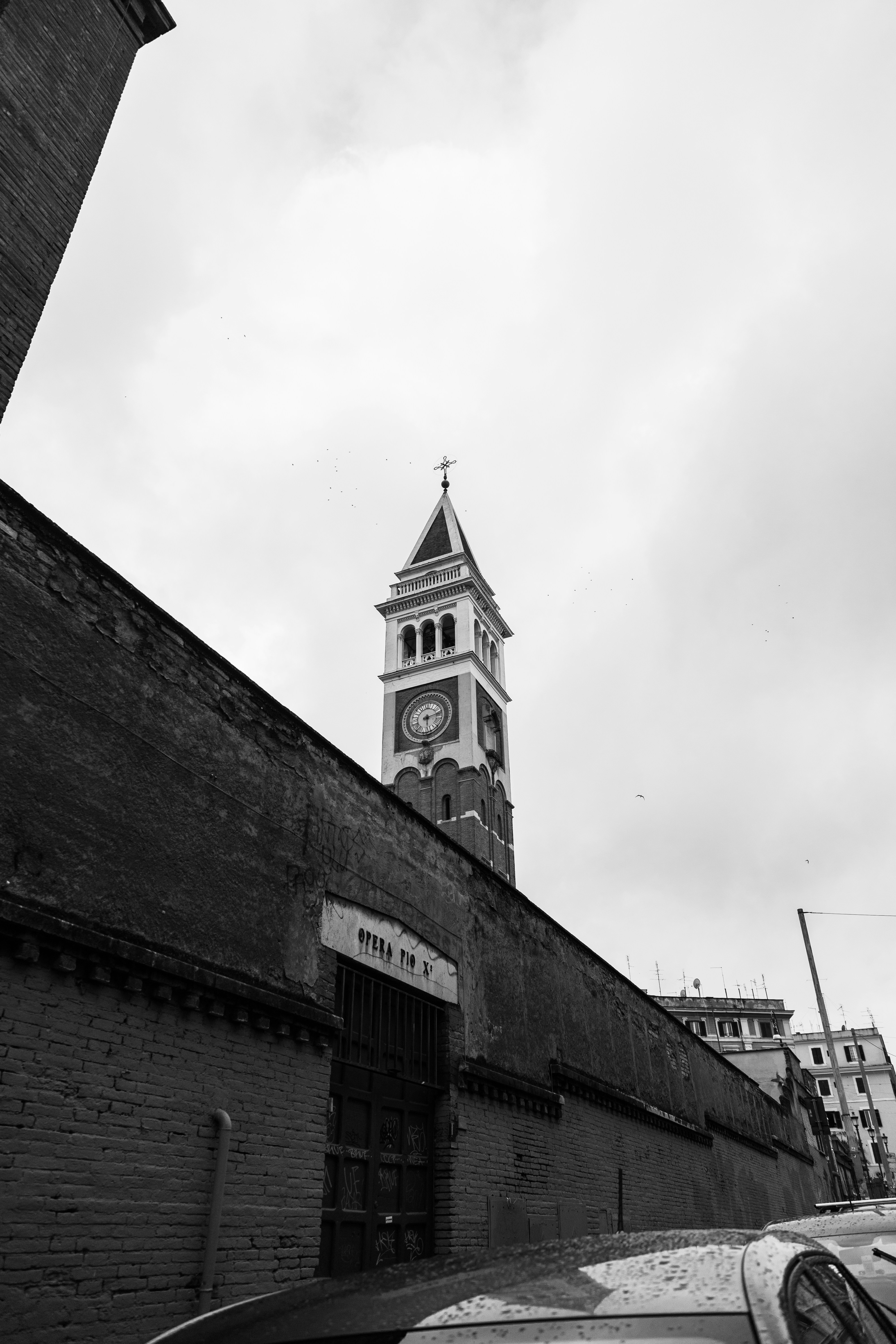 Clock Tower Rising Over an Aged Brick Fortification