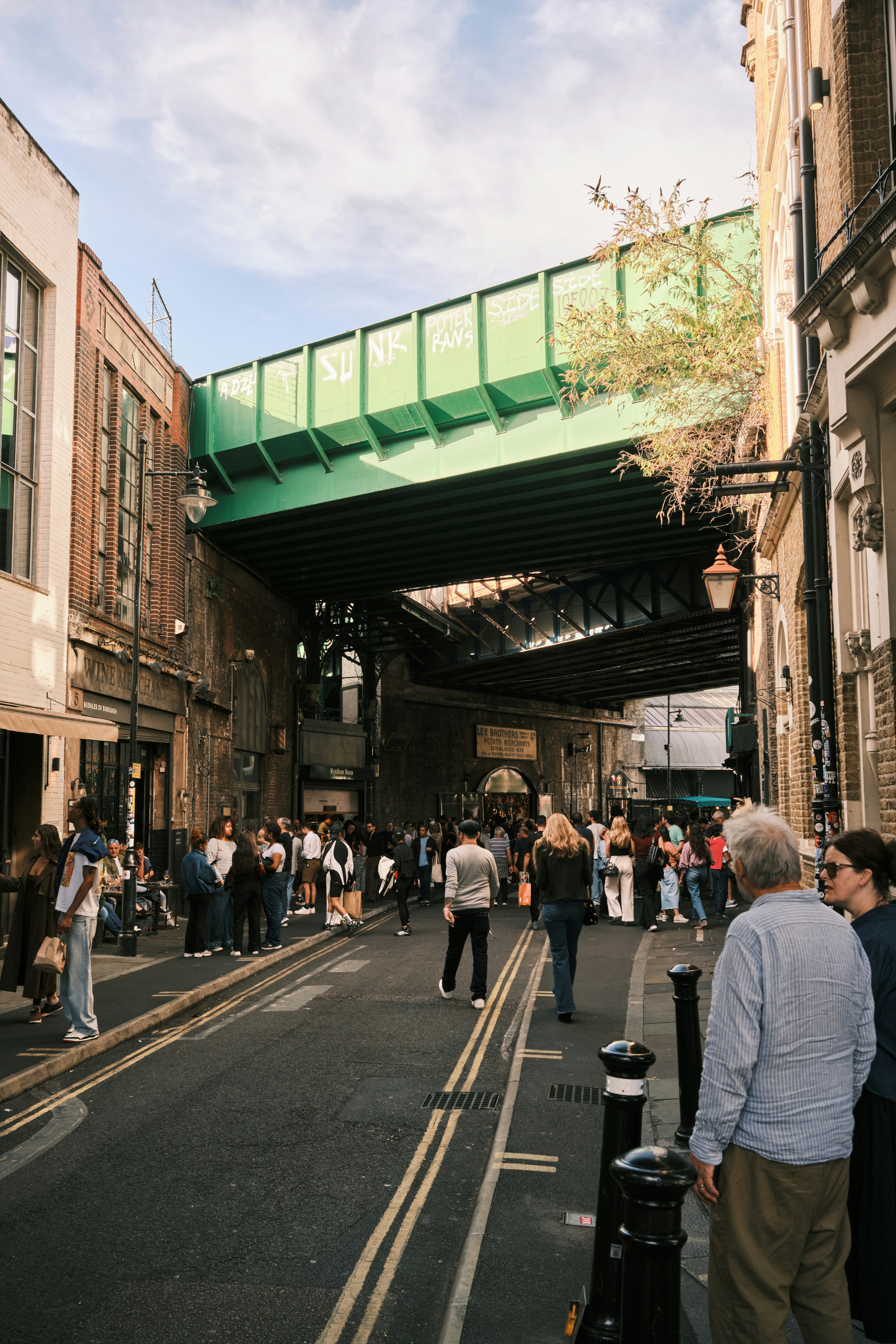 City under the Green Overpass: a crowd gathers beneath urban steel